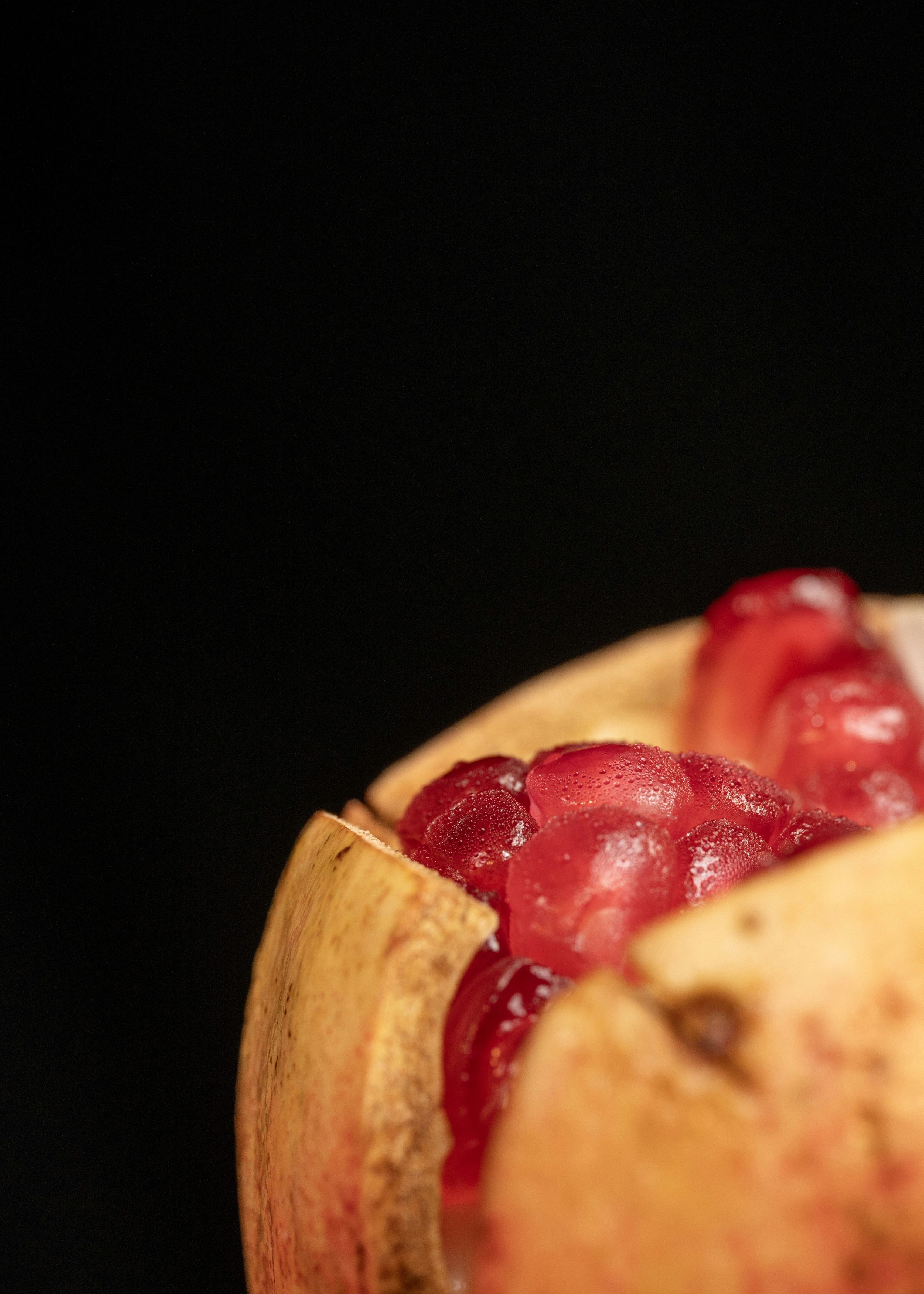 Gilded Pomegranate: Macro Burst of Red Seeds in Golden Husk