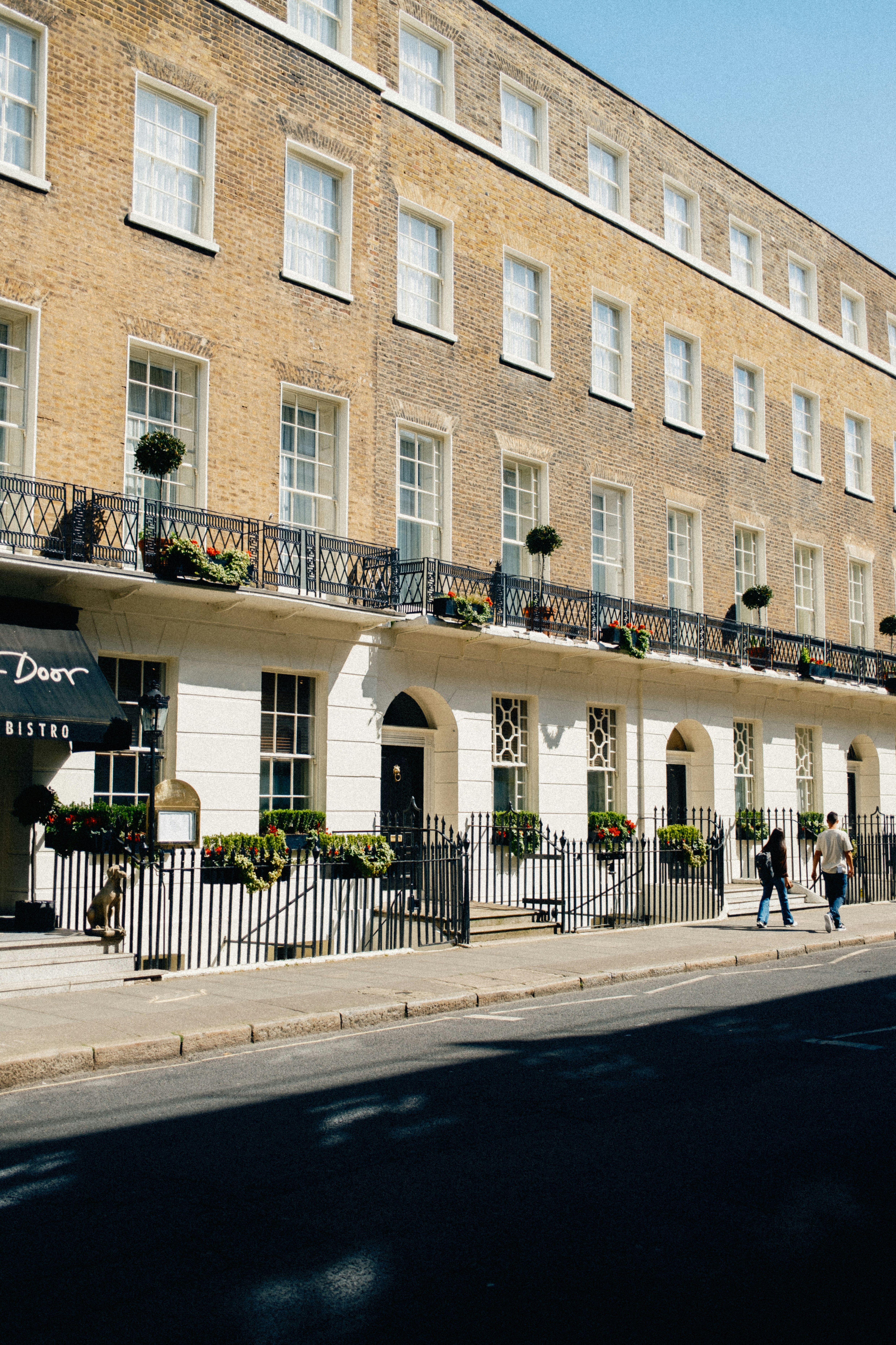 Row of Georgian townhouses with wrought-iron balconies and flower boxes