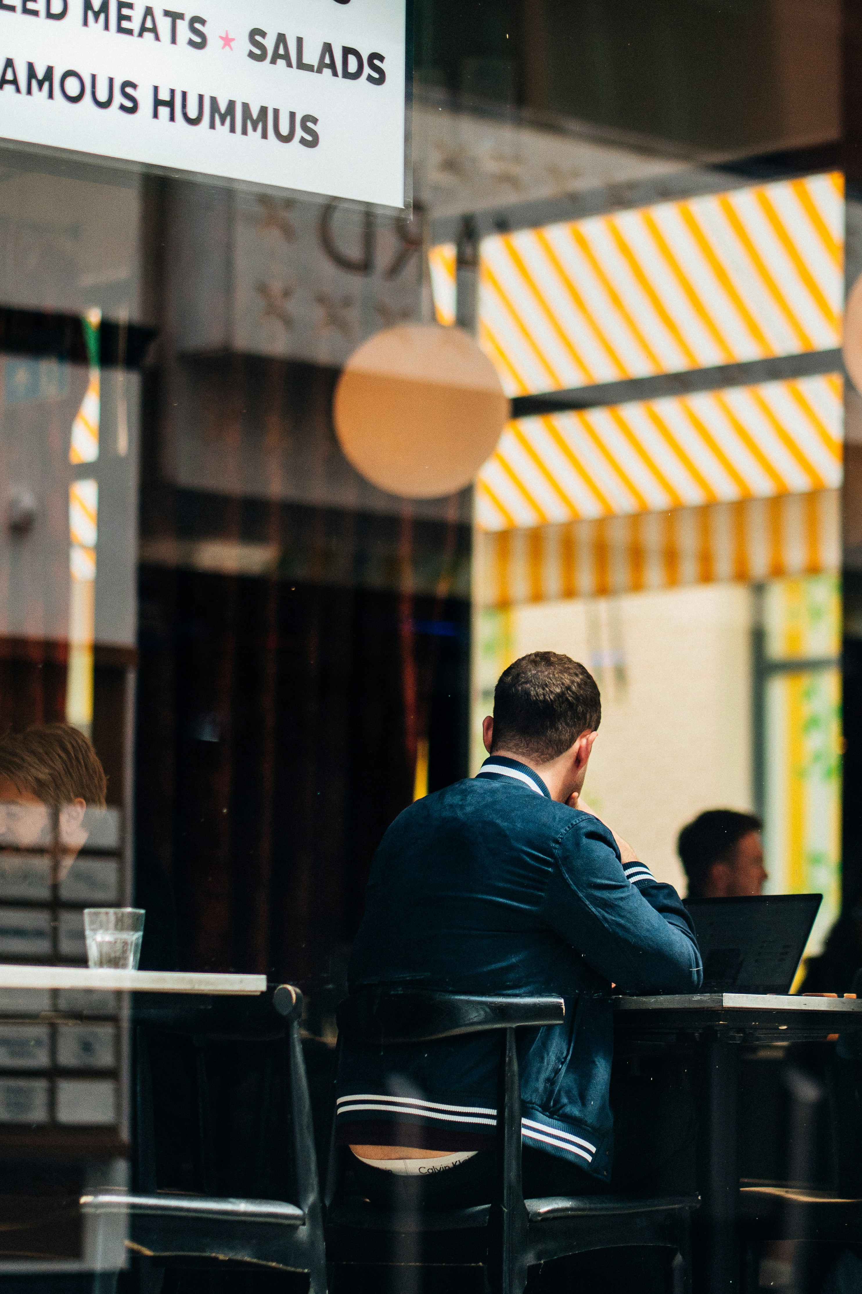 Cafe Corner: Focused Quiet Behind a Laptop Screen