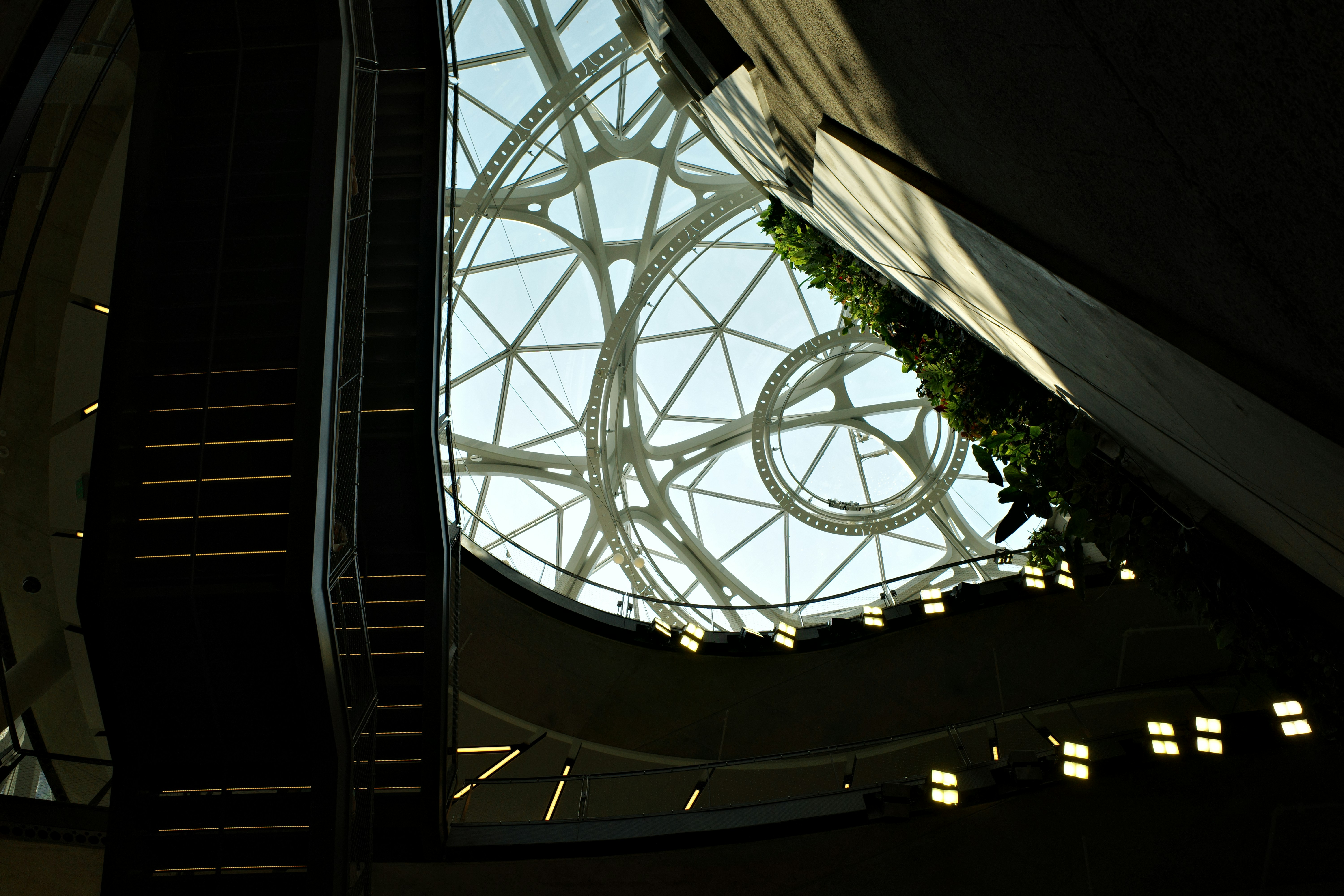 Geometric Atrium: Glass Circles Framed by Steel Ramps