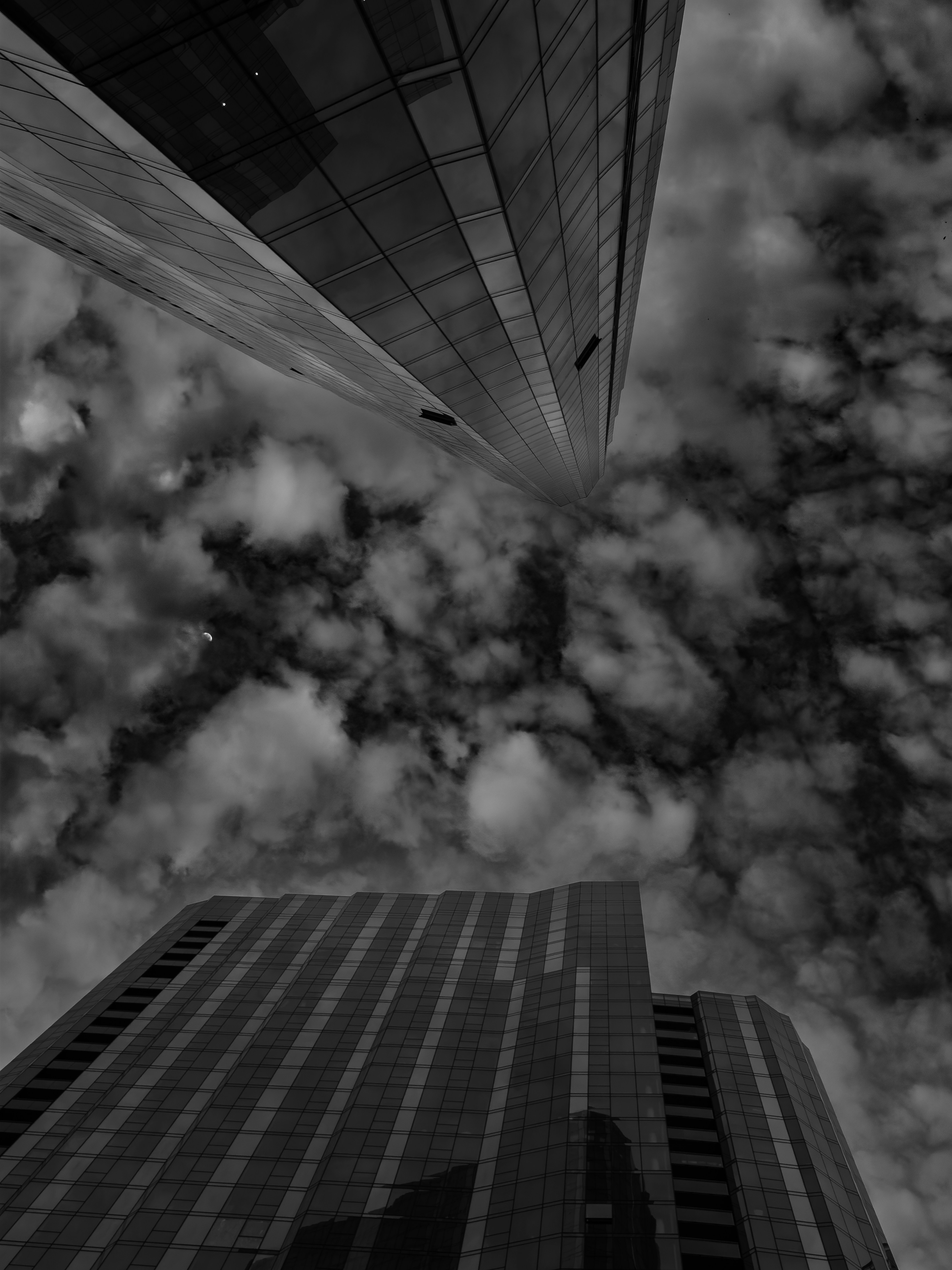 Towering Ascent: A Skyward Perspective Between Glass and Cloud