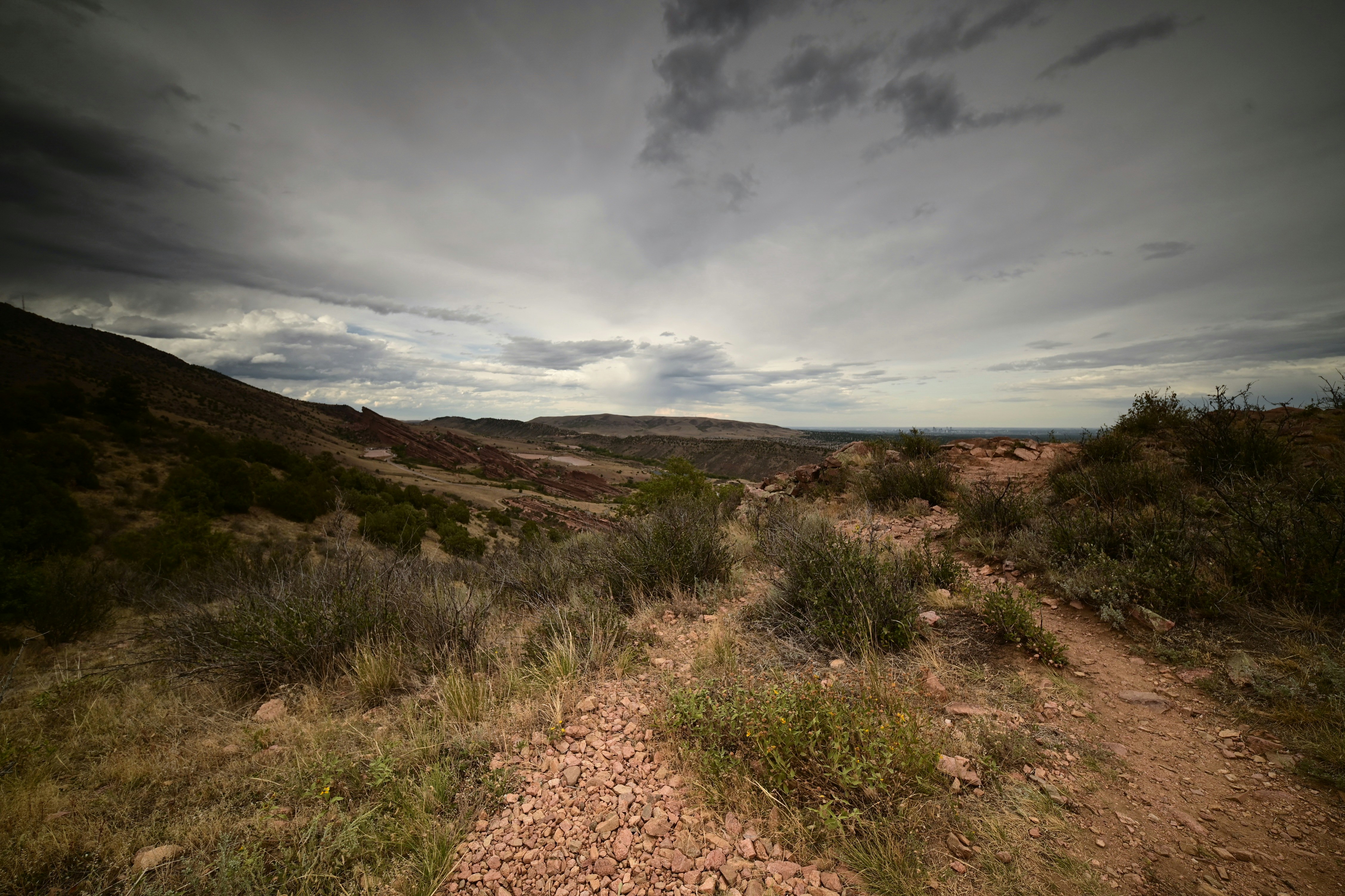 Desert Panorama at Dusk: A Winding Trail into the Open Rift