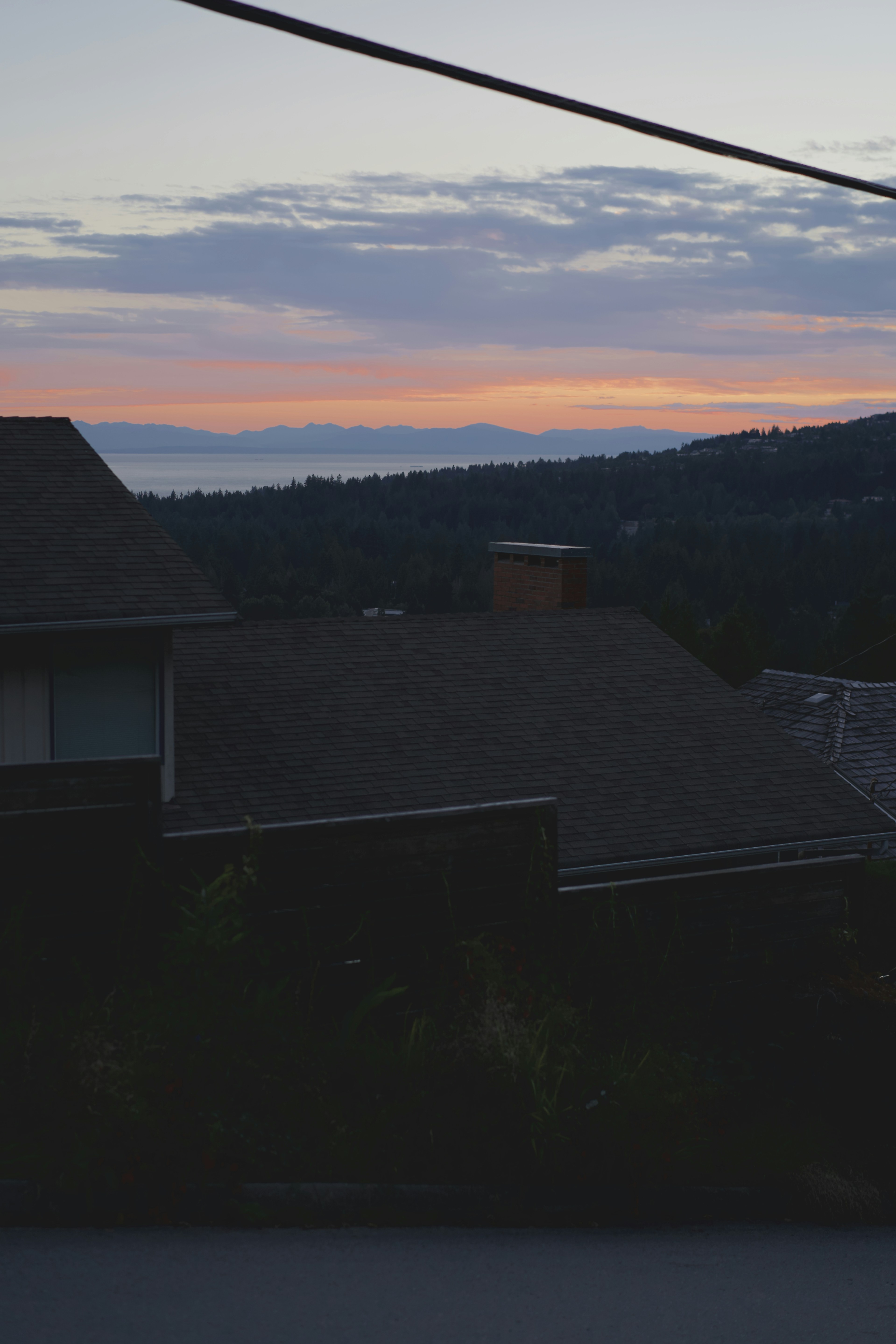 Horizon Sunset Behind Quiet Neighborhood Rooftops