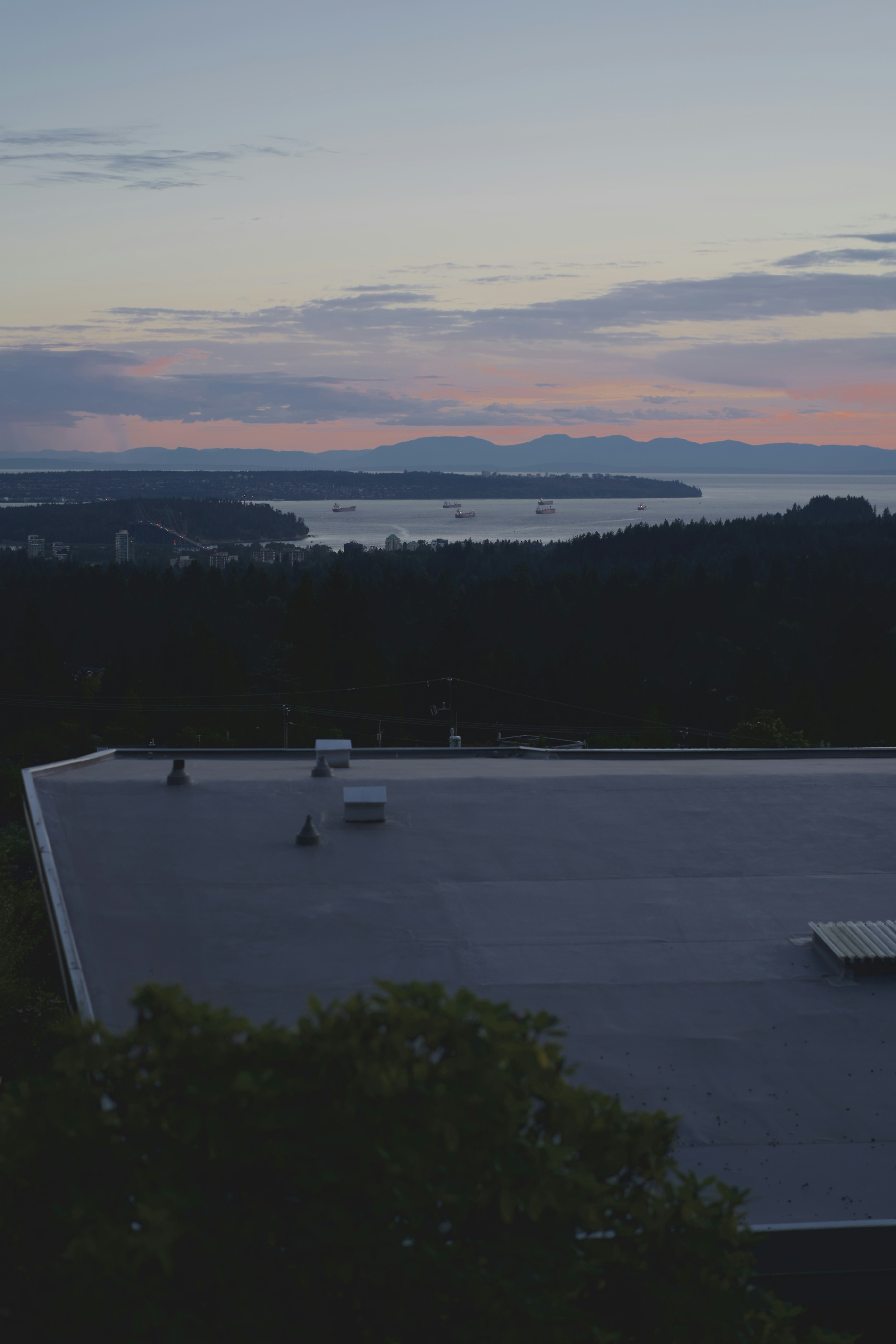 Distant harbor at sunset from a rooftop overlook