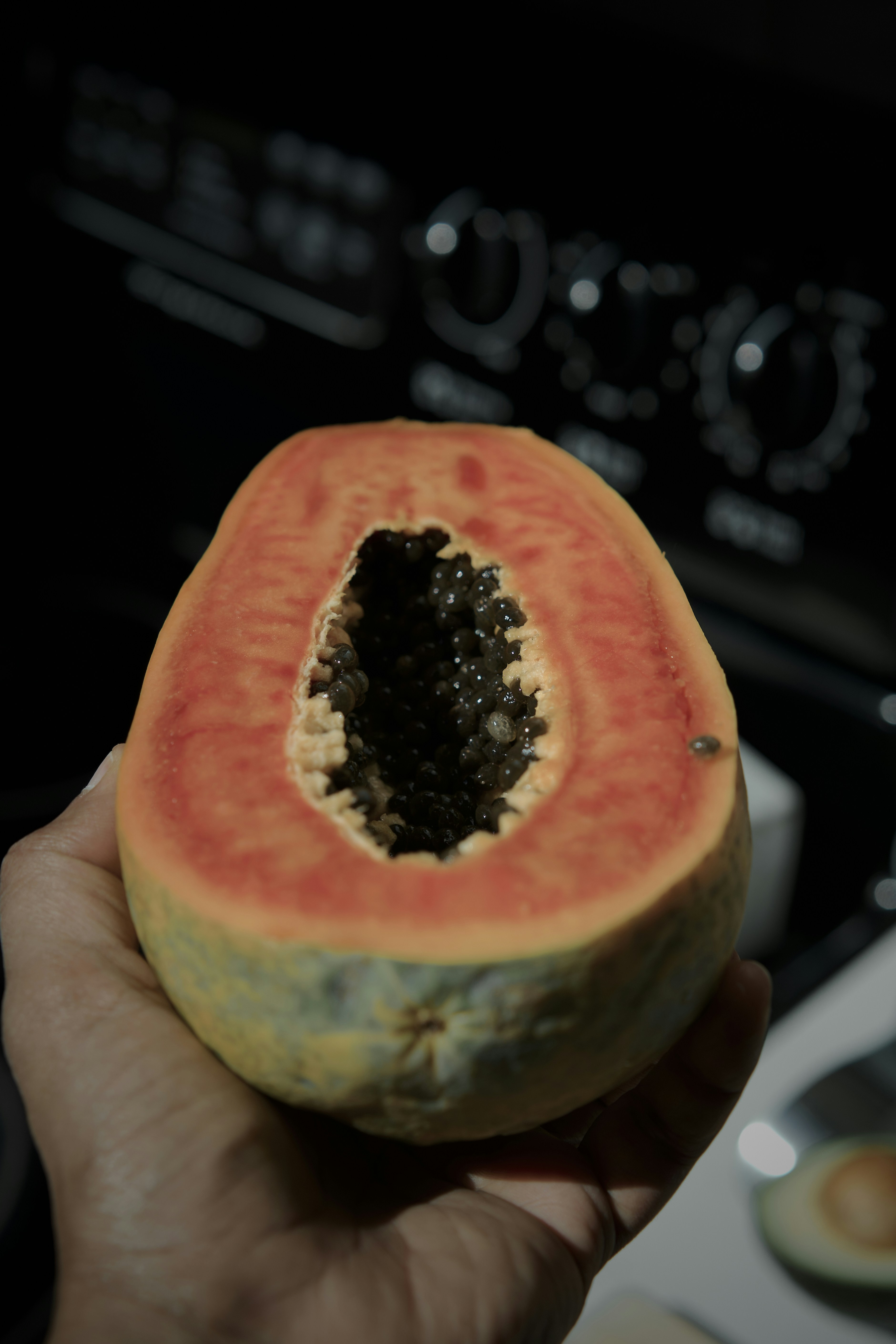 Hand-Held Papaya Half: Inward Focus on Seeded Cavity