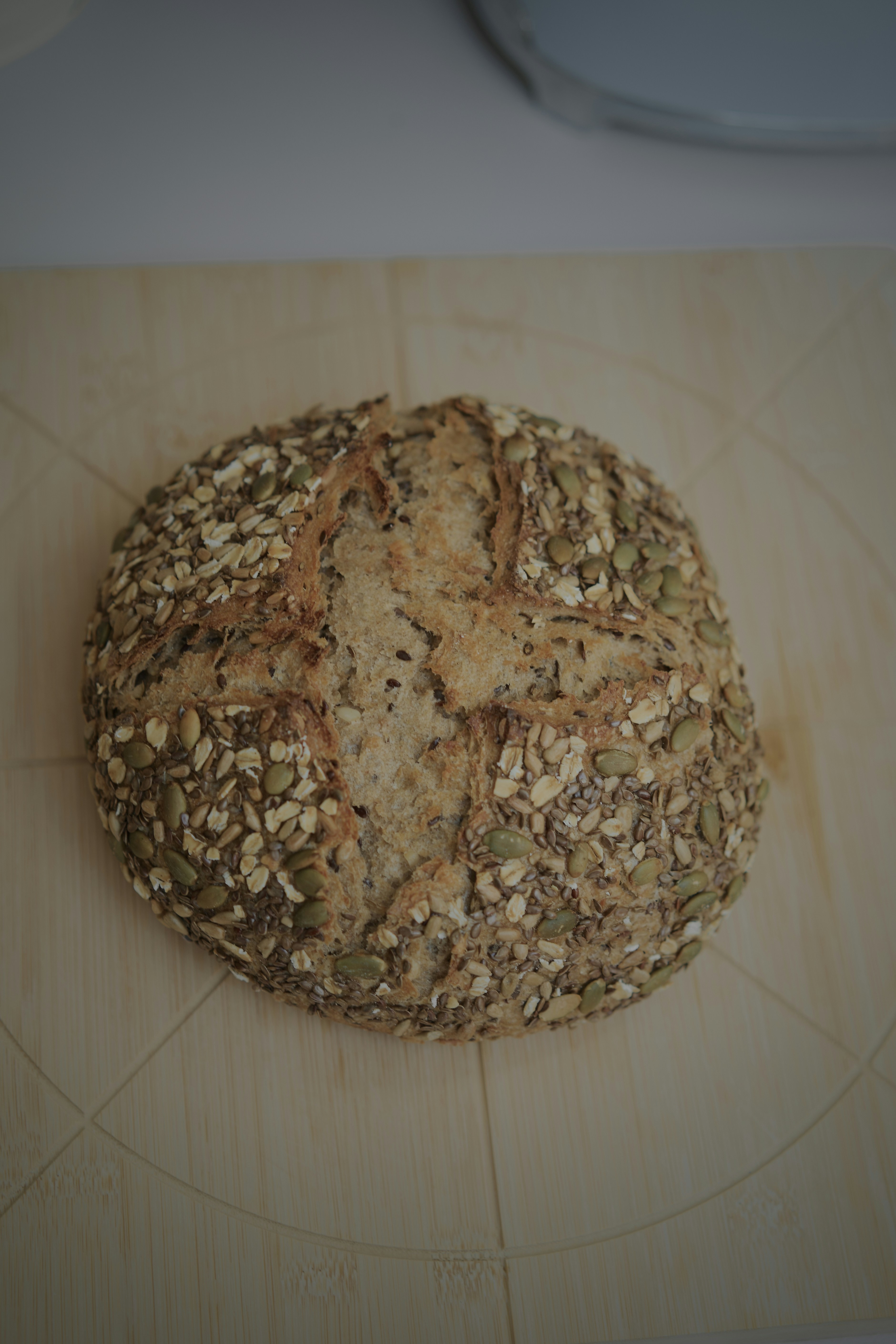 Seeded Round loaf resting on a wooden cutting board