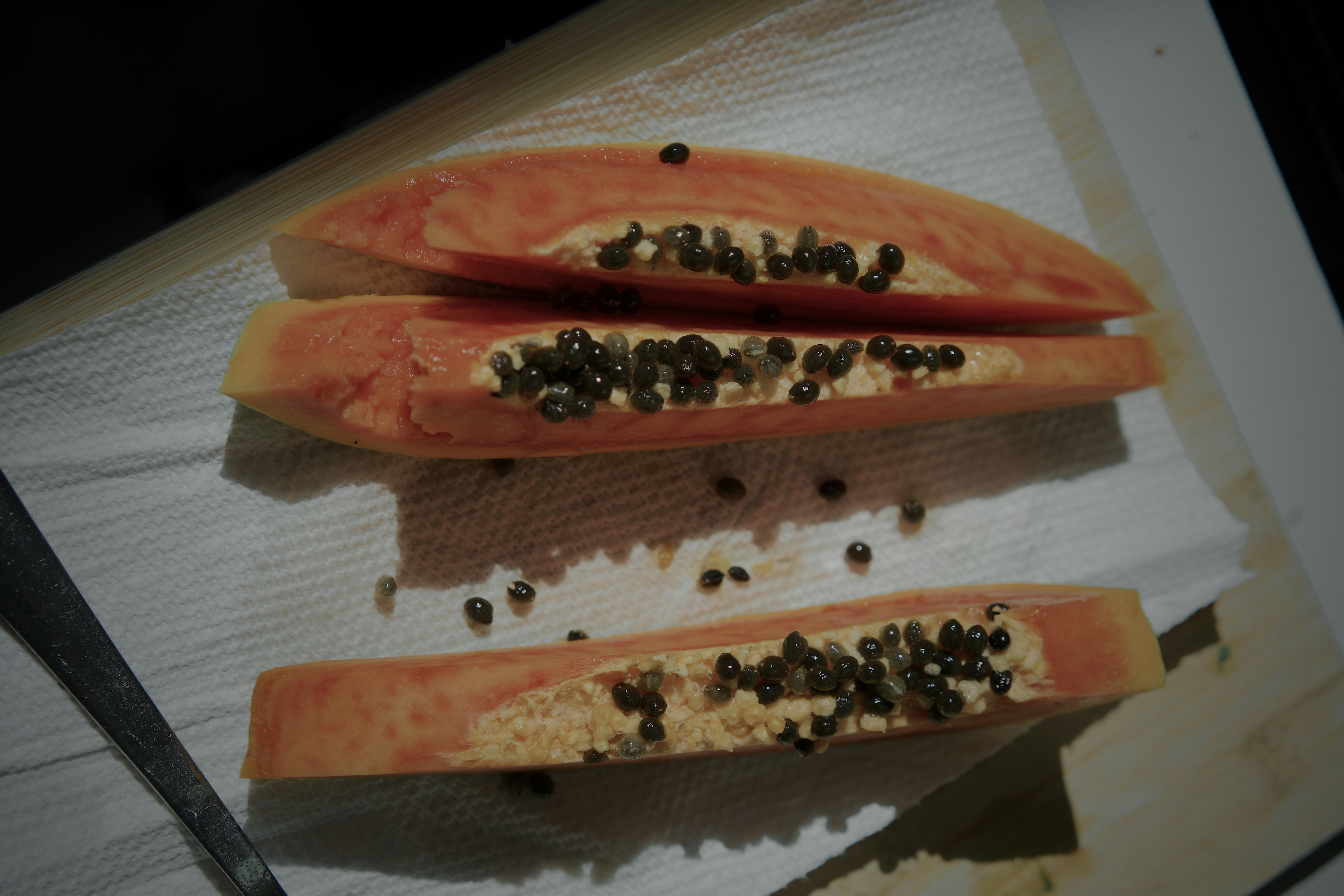Citrus-orange Papaya Halves Mossed with Black Seeds on a Paper Towels