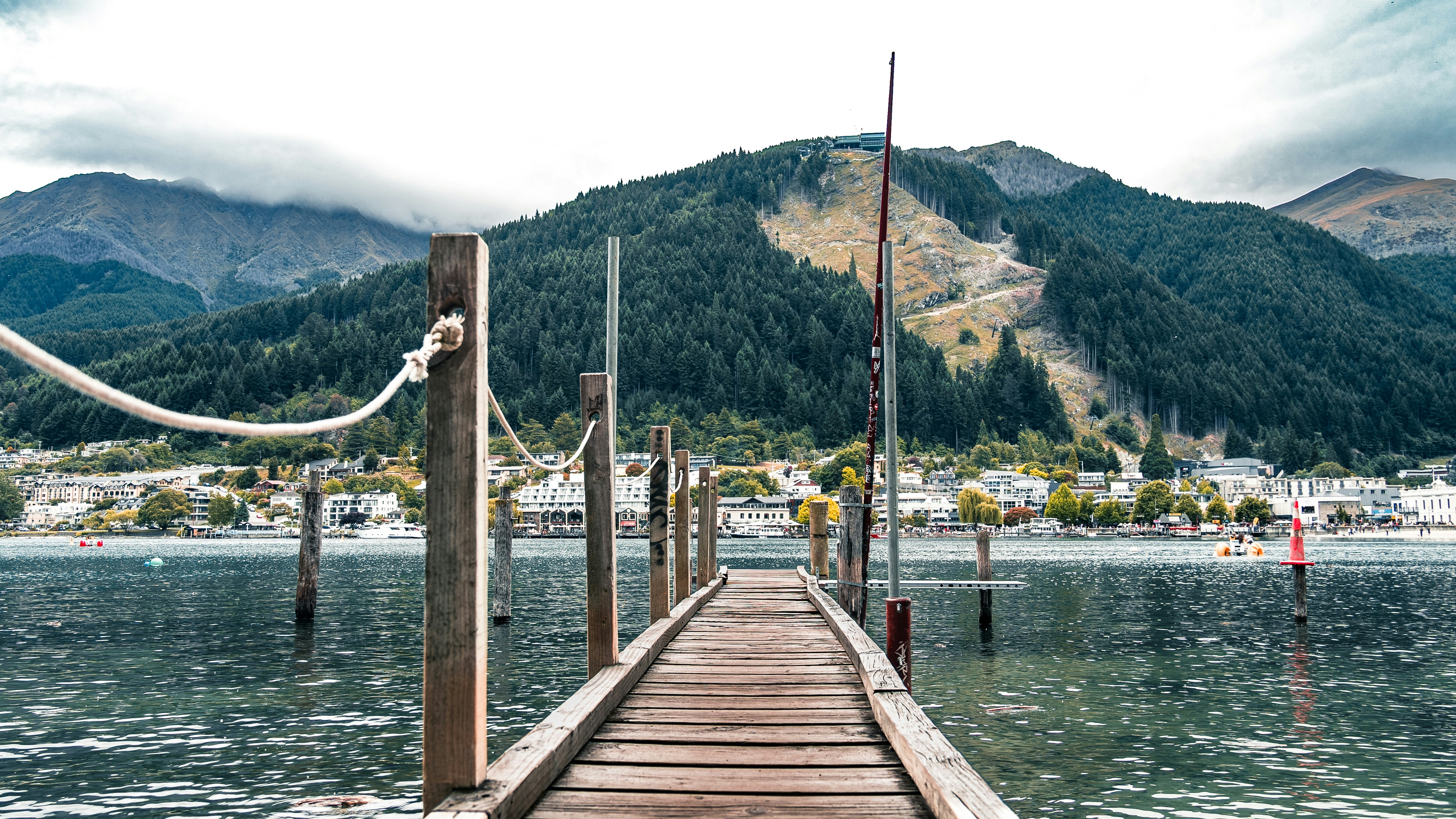 Dock Between Mountains: A Quiet Pier Reaching Toward the Lake Town