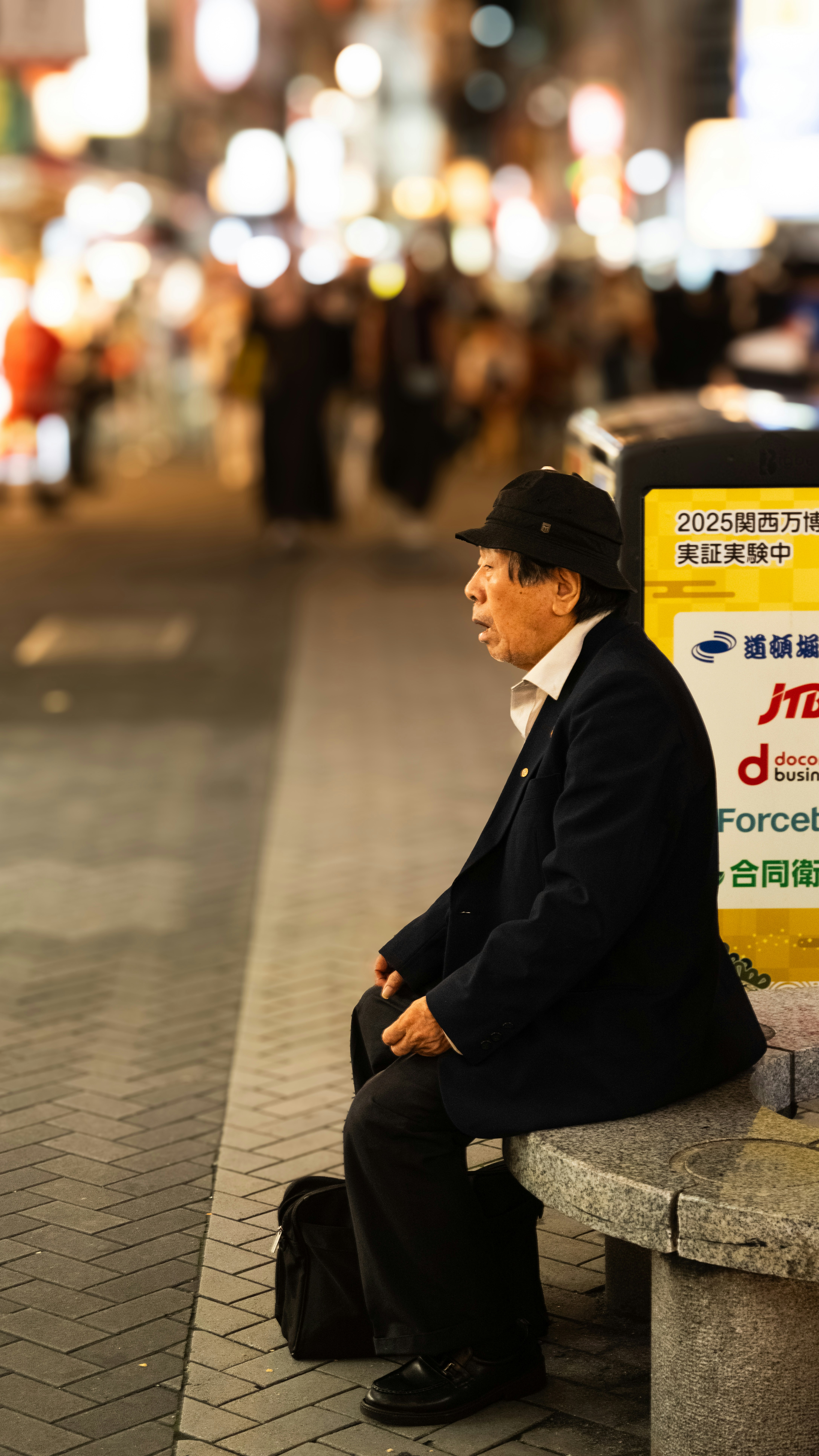 Quiet Vigil on a Neon Street