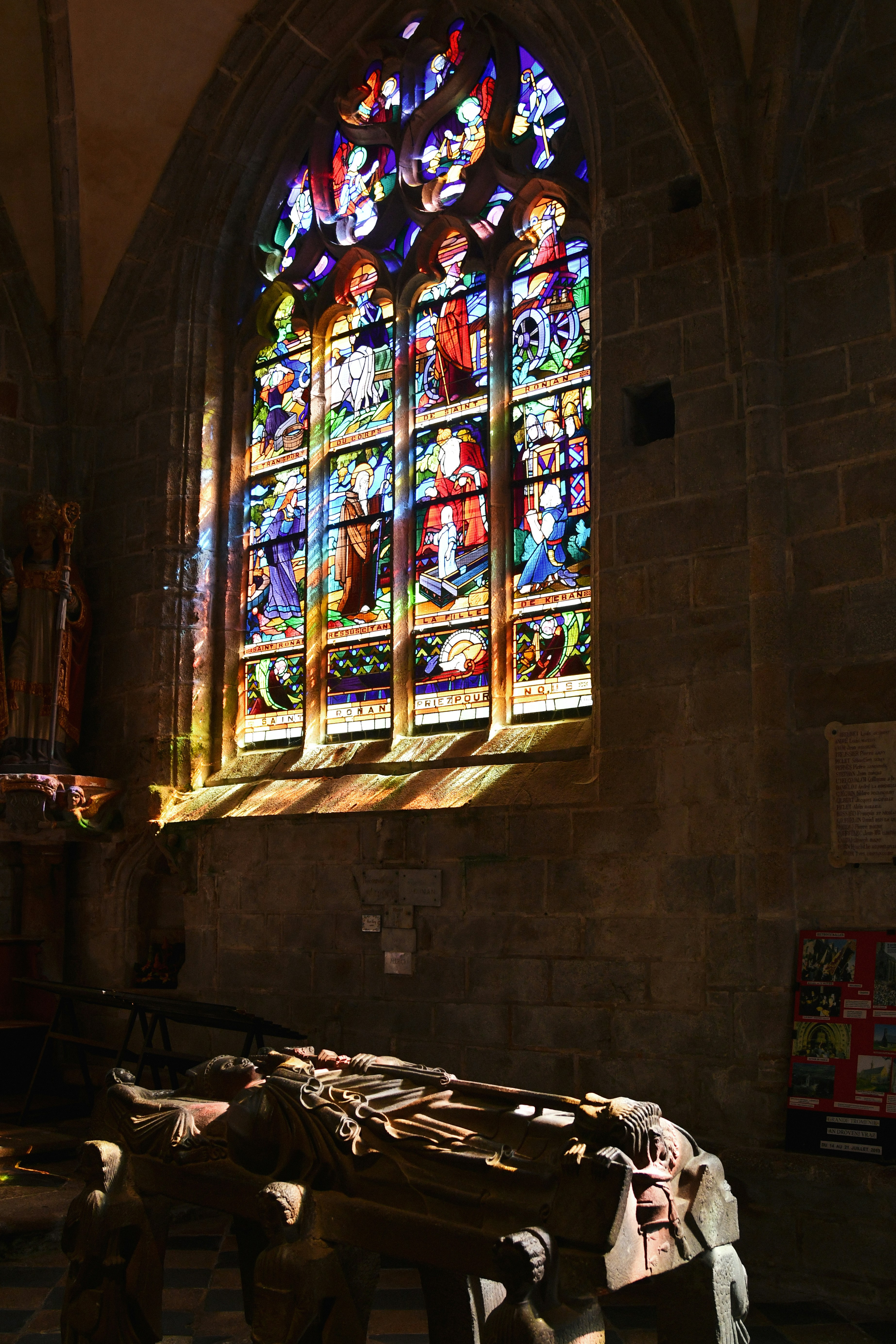Stained Glass Cathedral Light Casting Shadows Over a Stone Tomb