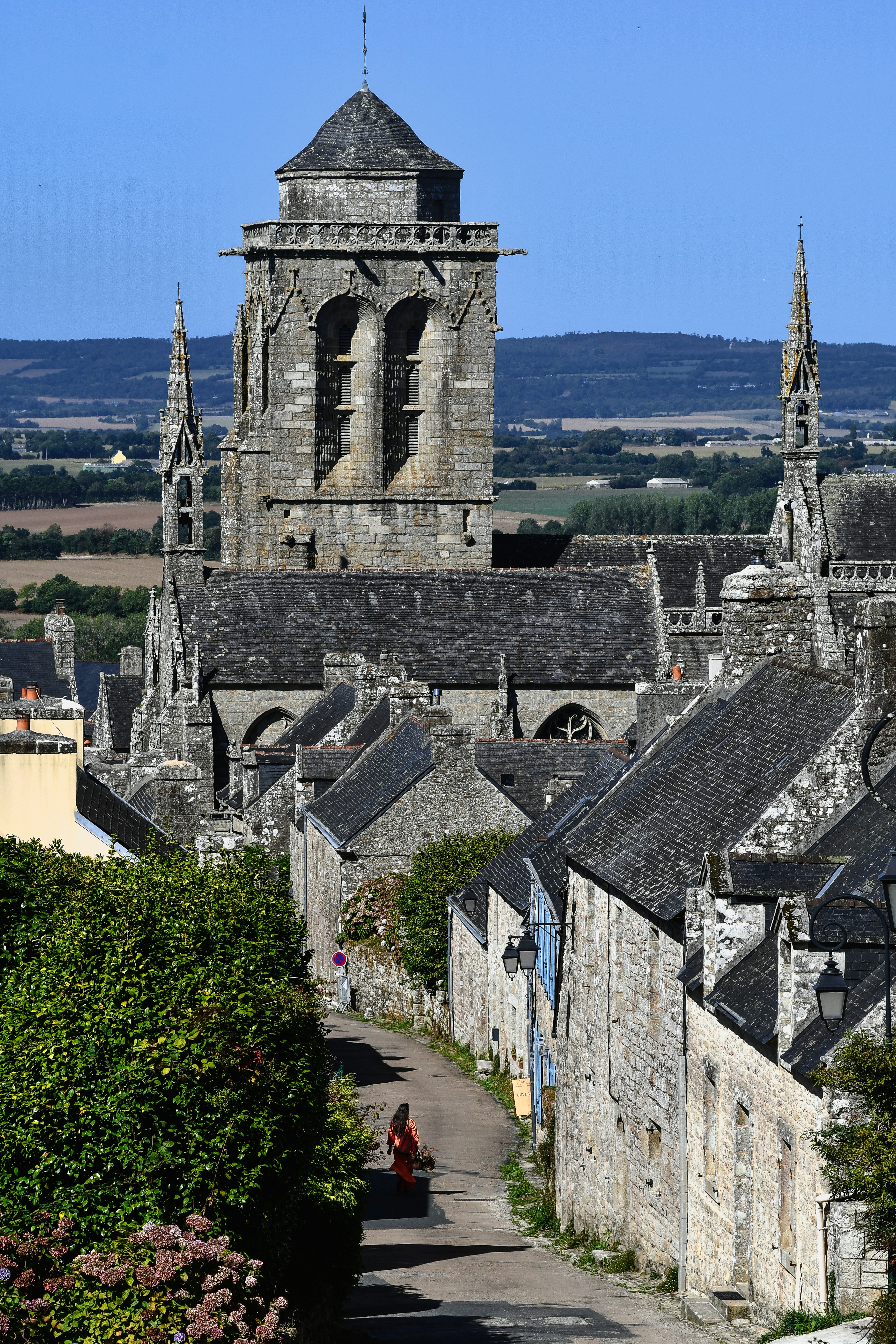 Stone Choir: A French Village Cathedral Rising Above Narrow Shaded alleys