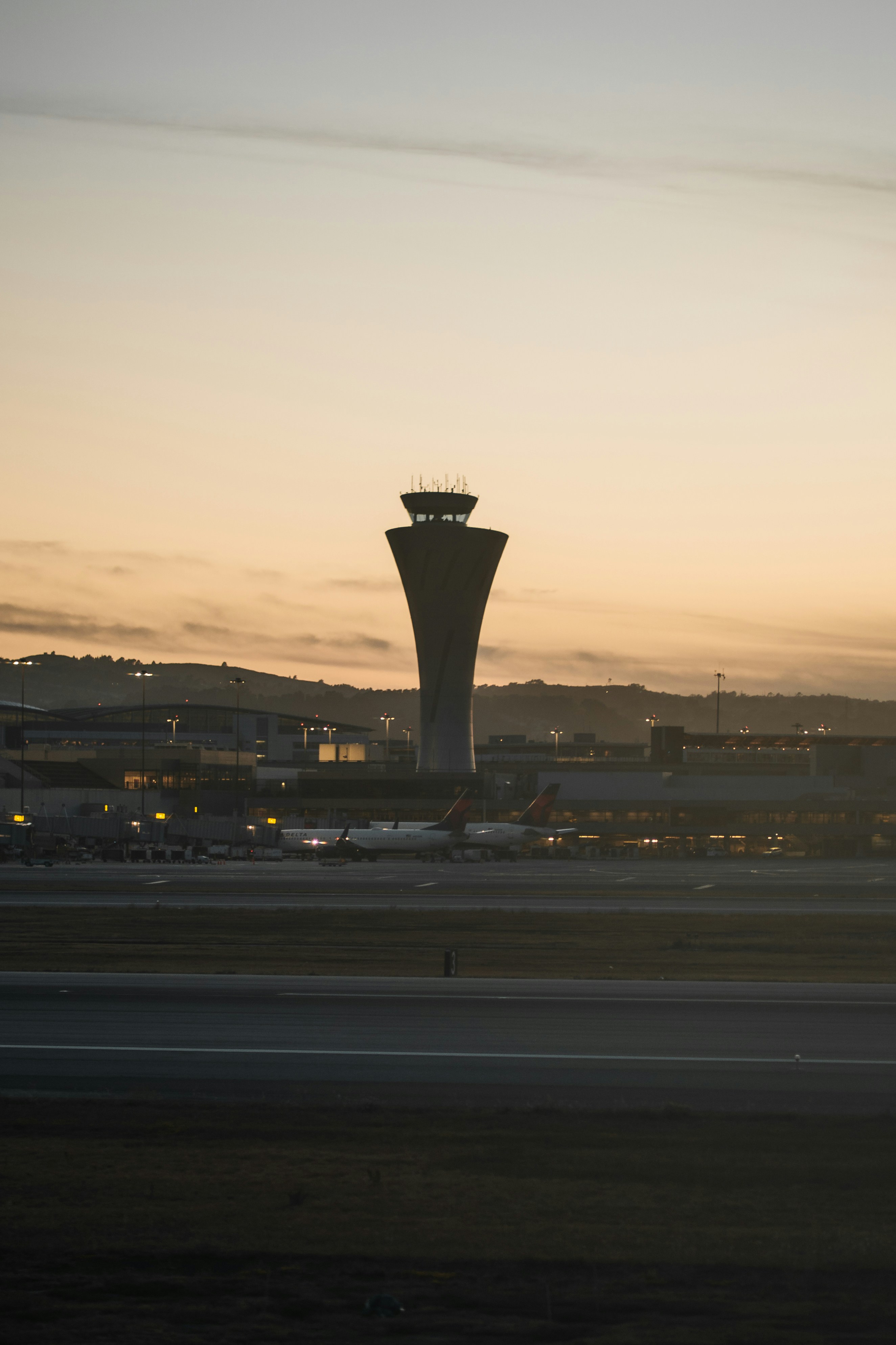 Control Tower at Dusk: Quiet Precision Over Runway Lights
