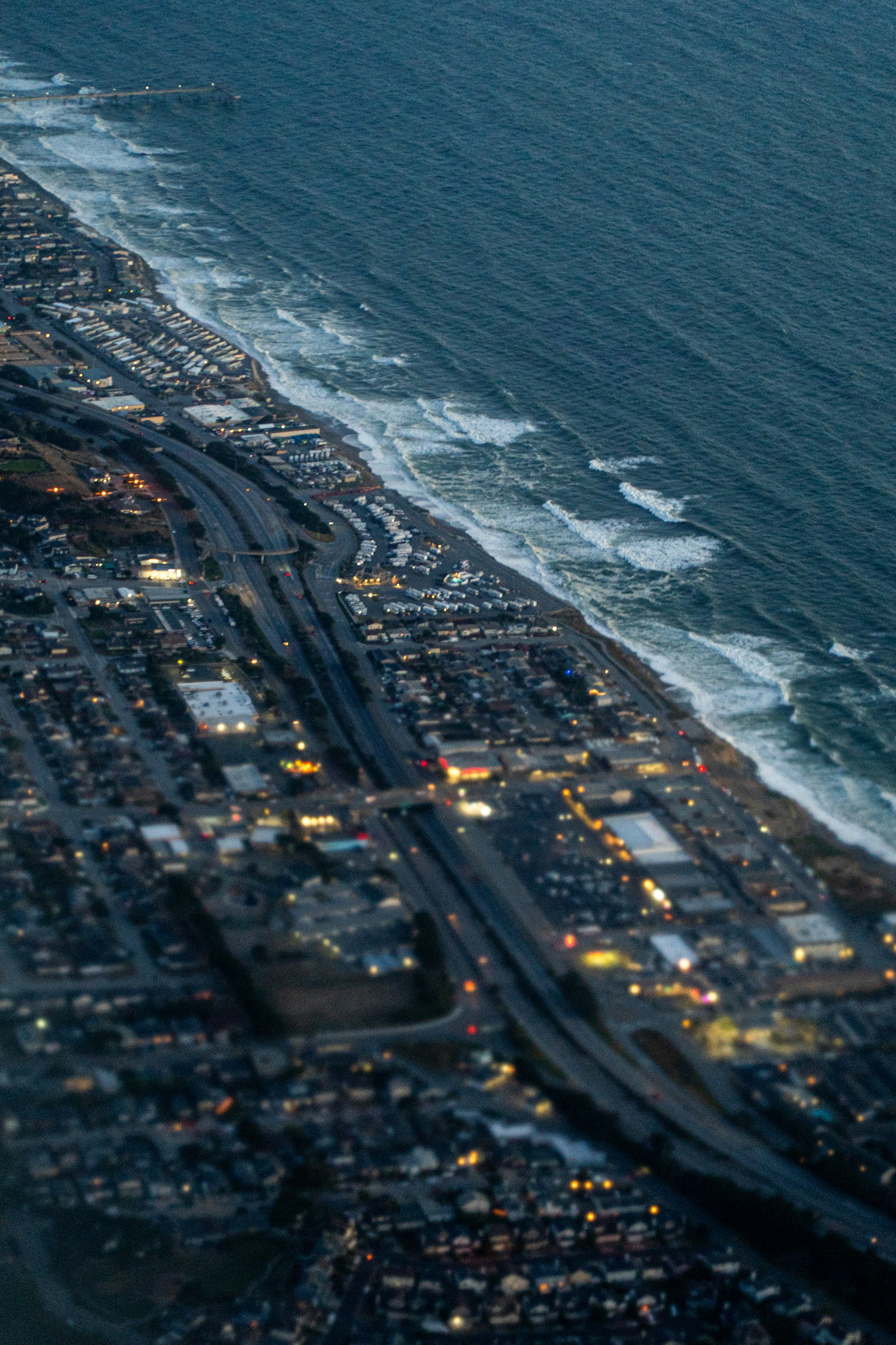 Coastal Grid: Aerial Quiet Over a Distant City by the Sea