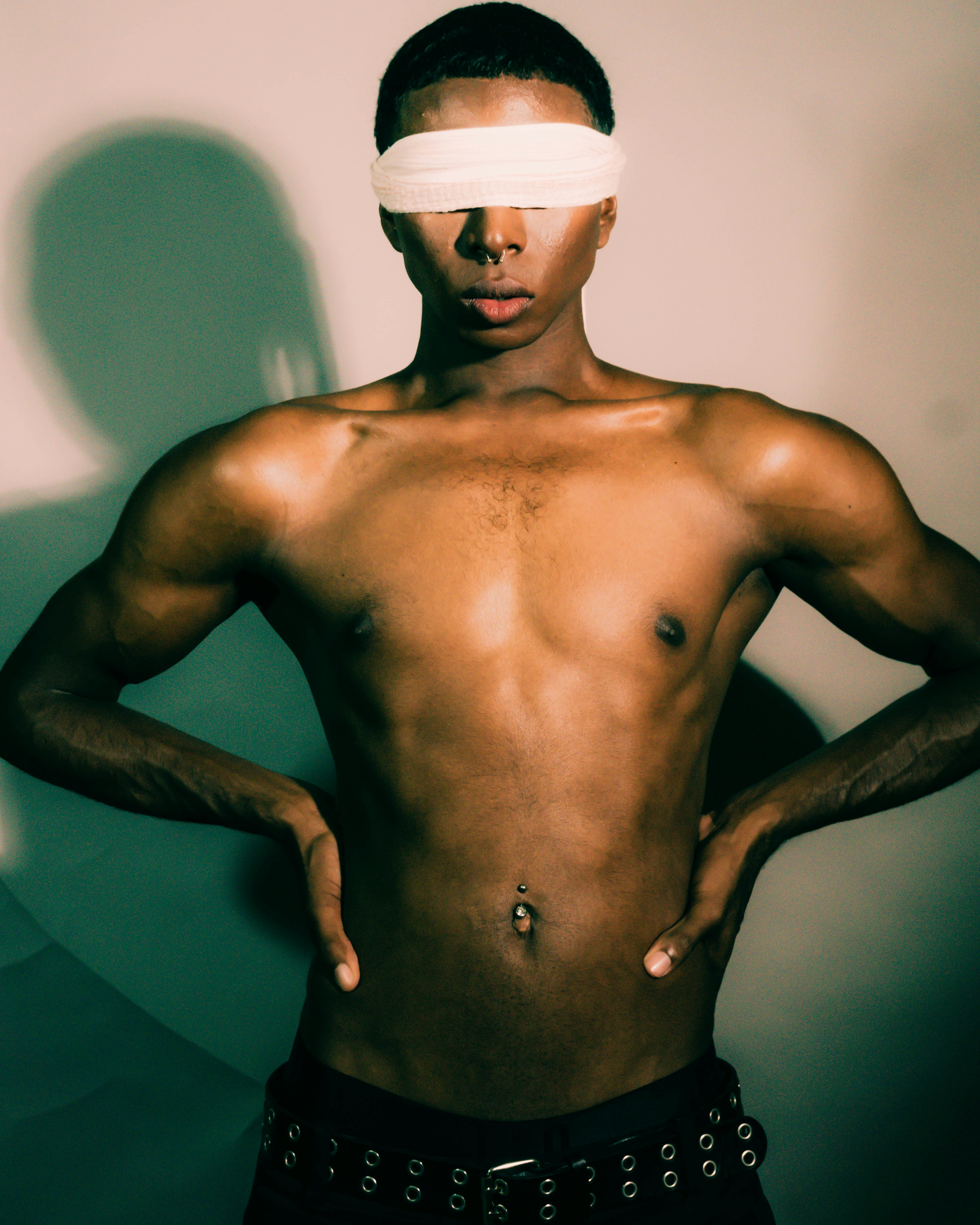 Blindfolded Confidence: Portrait of Strength in Shadowed Light