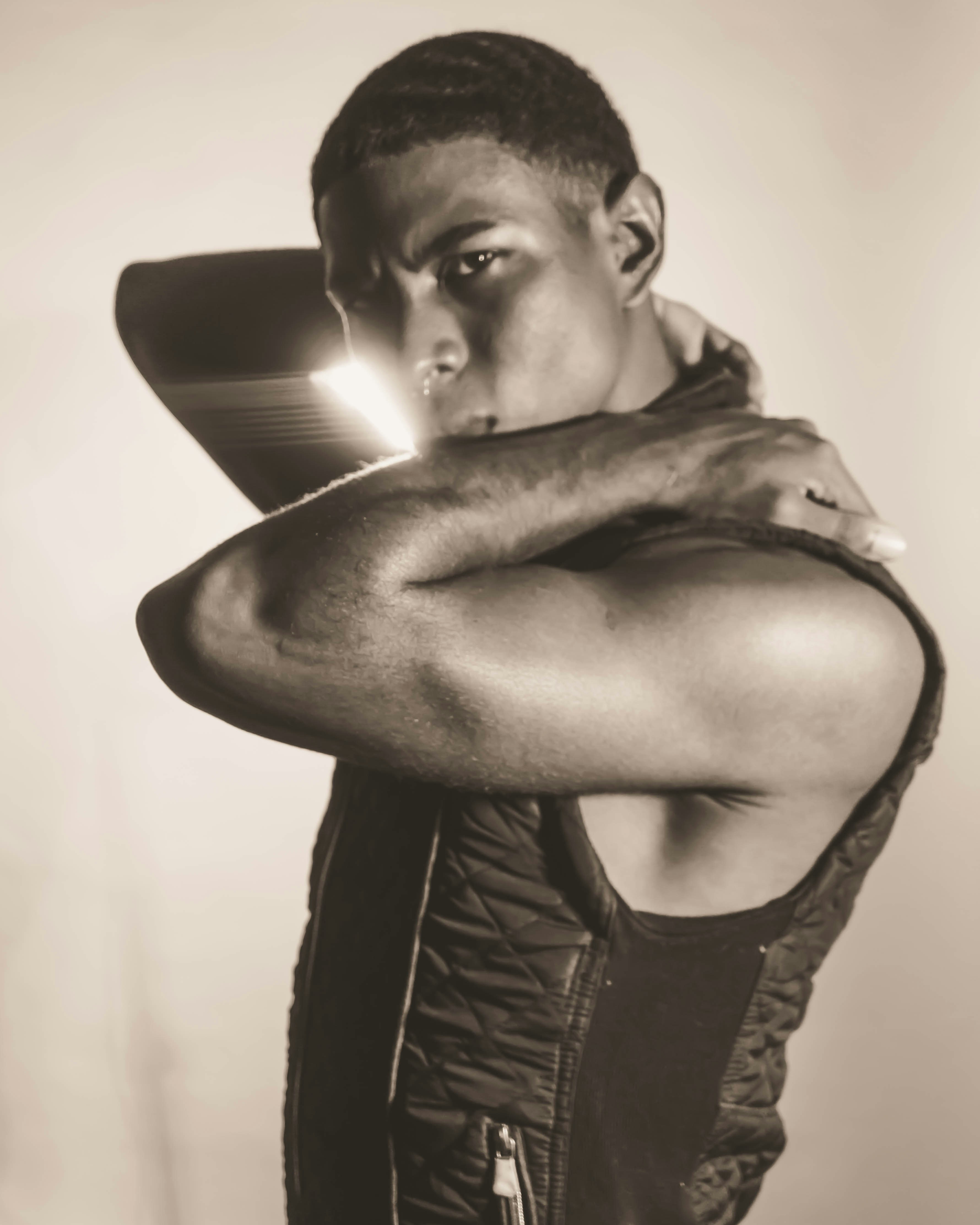 Shadowed Gaze: A Confident Pose in Sepia Tone