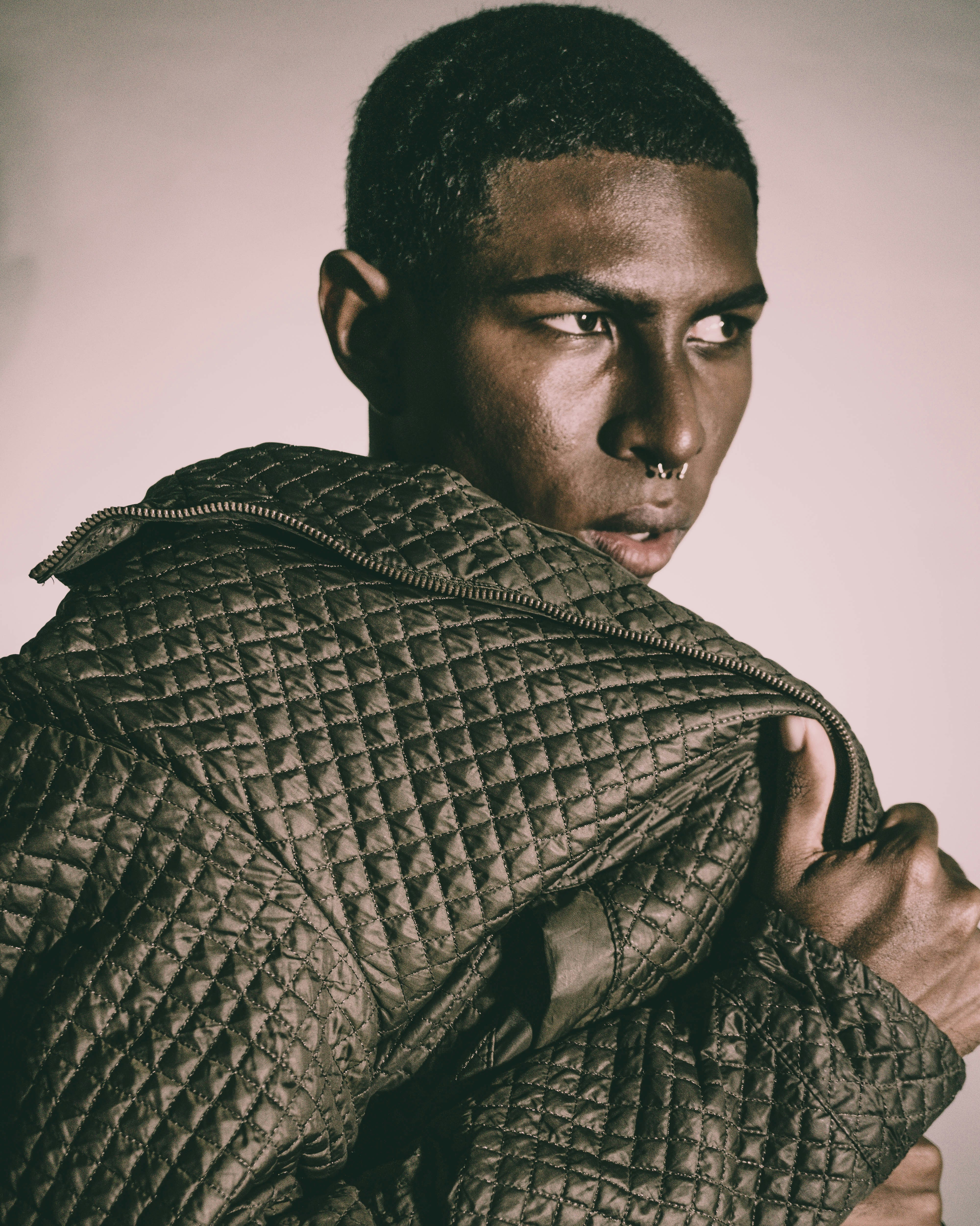 Shadowed Gaze in a Quilted Jacket