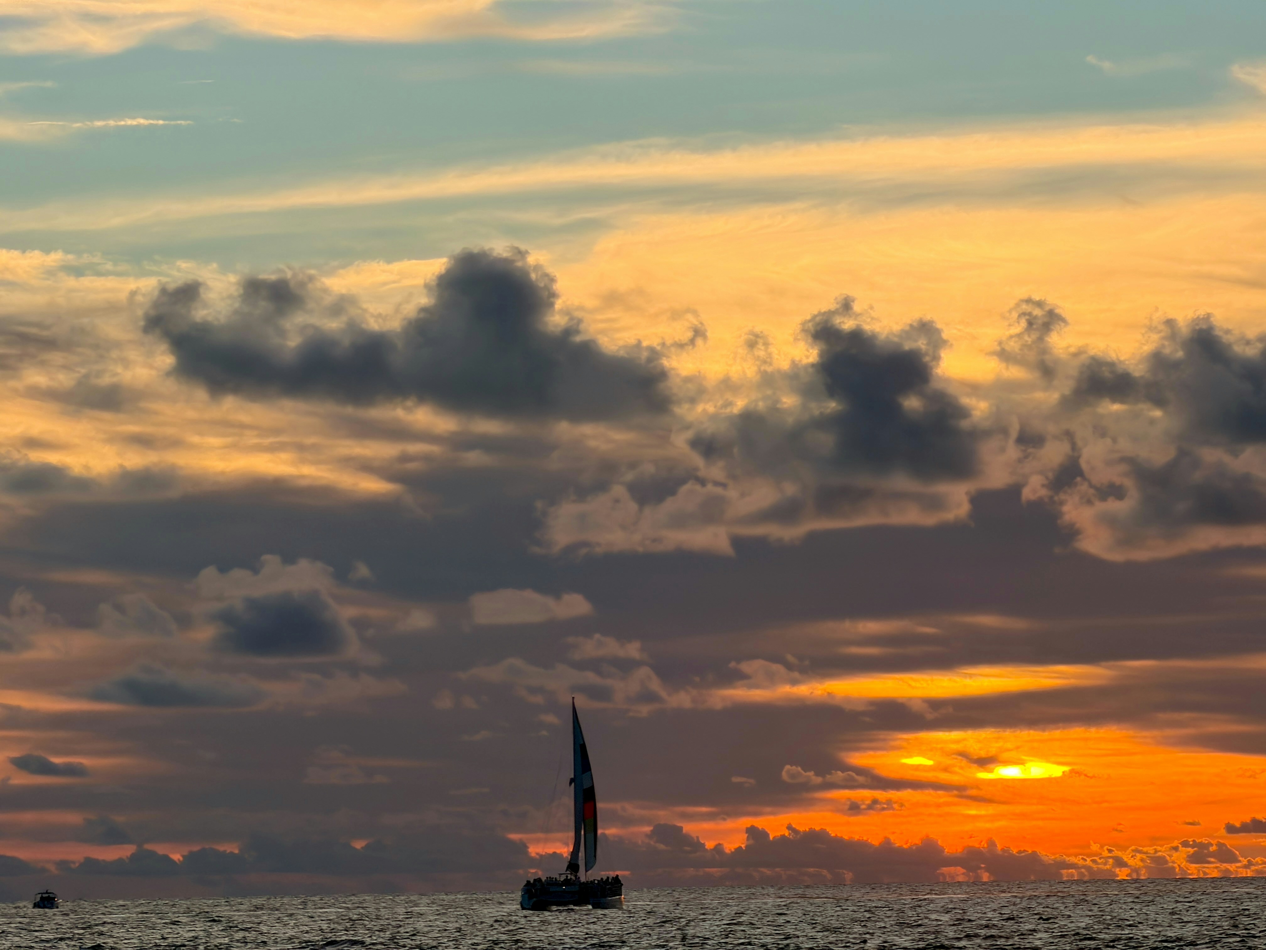 Sailboat at Dusk: Silhouette Against a Golden Sea