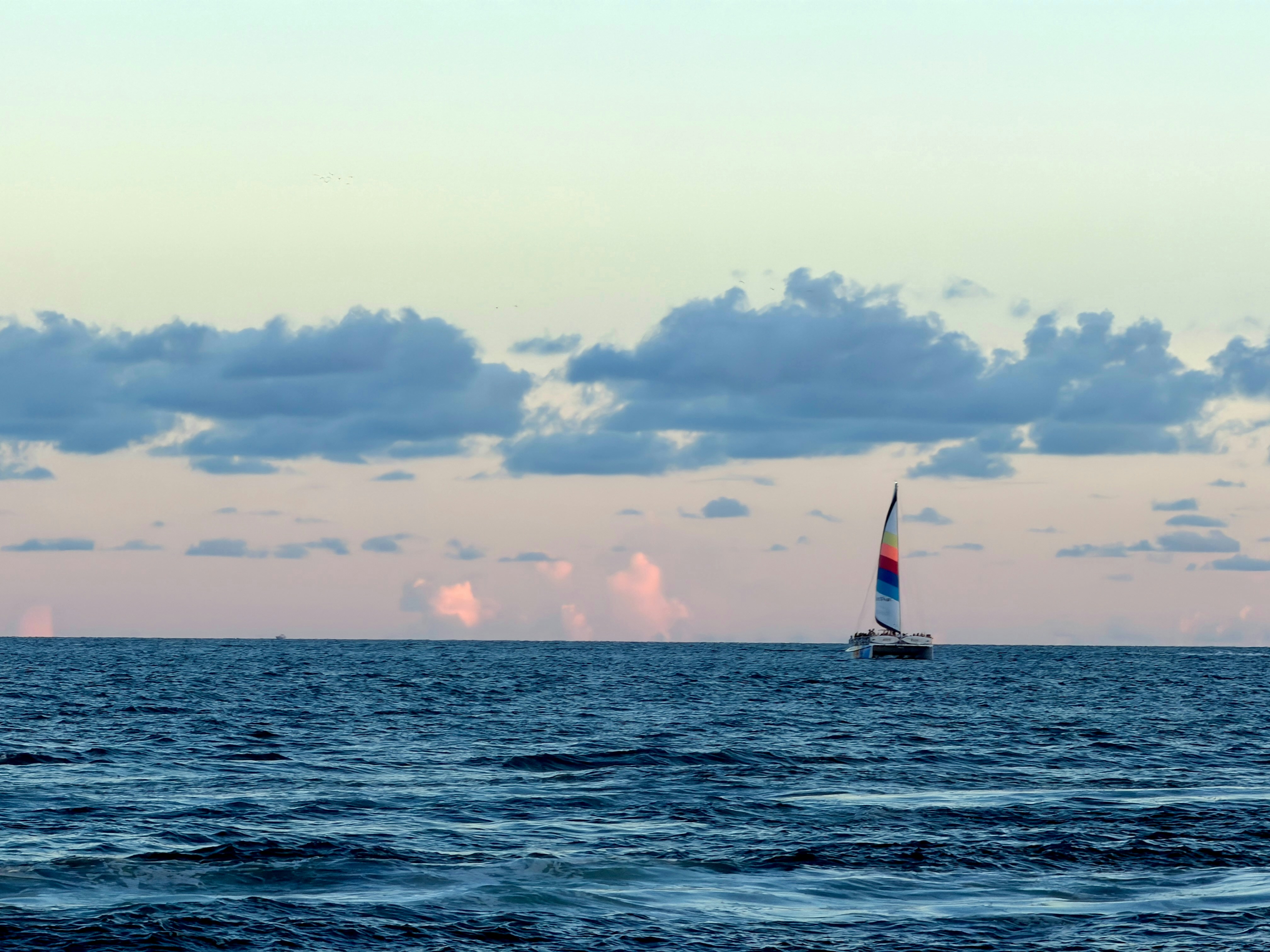 Sailboat on a Calm Horizon at Dusk