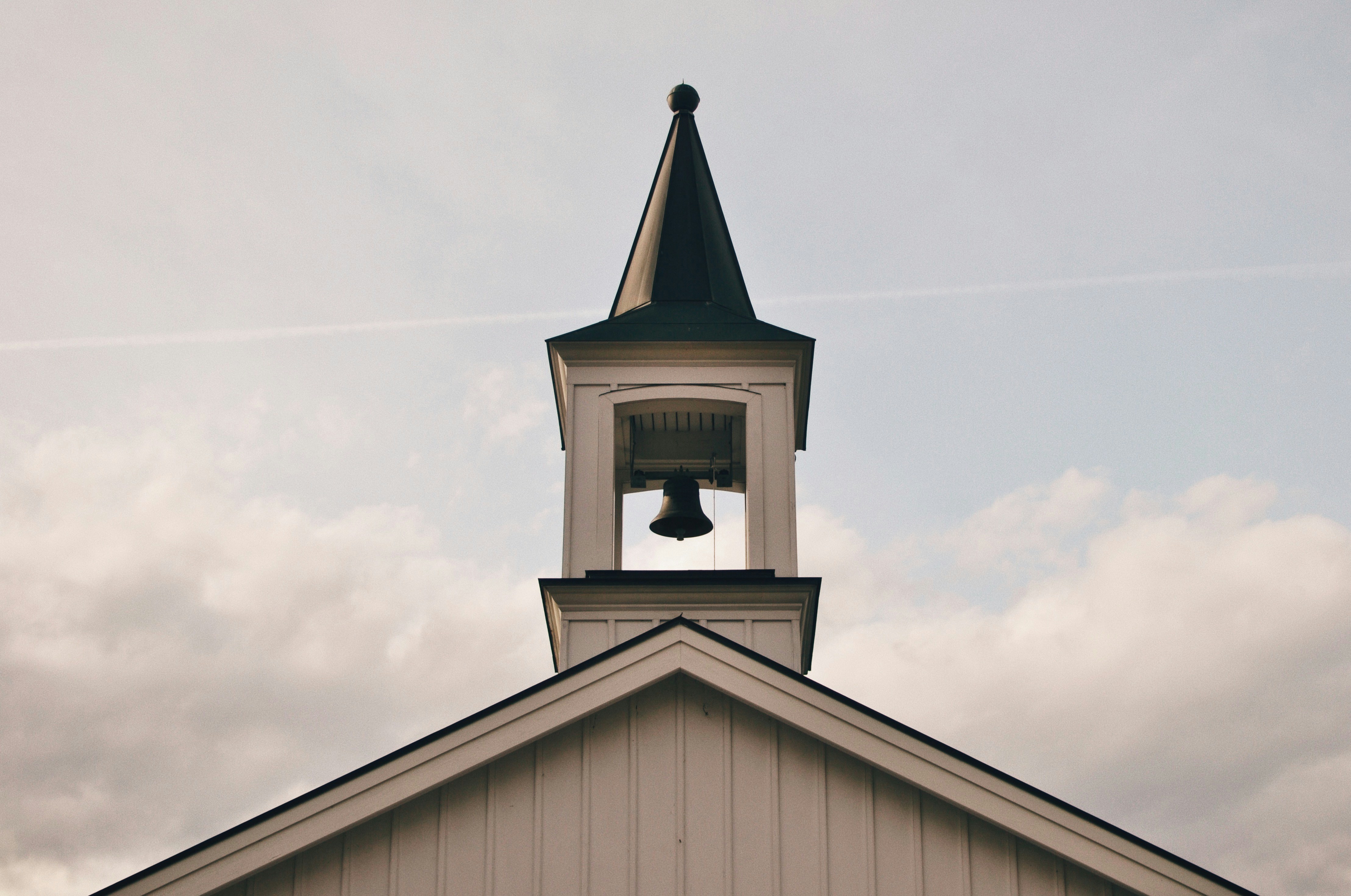 Bell Tower Above the Church Roof at Dusk