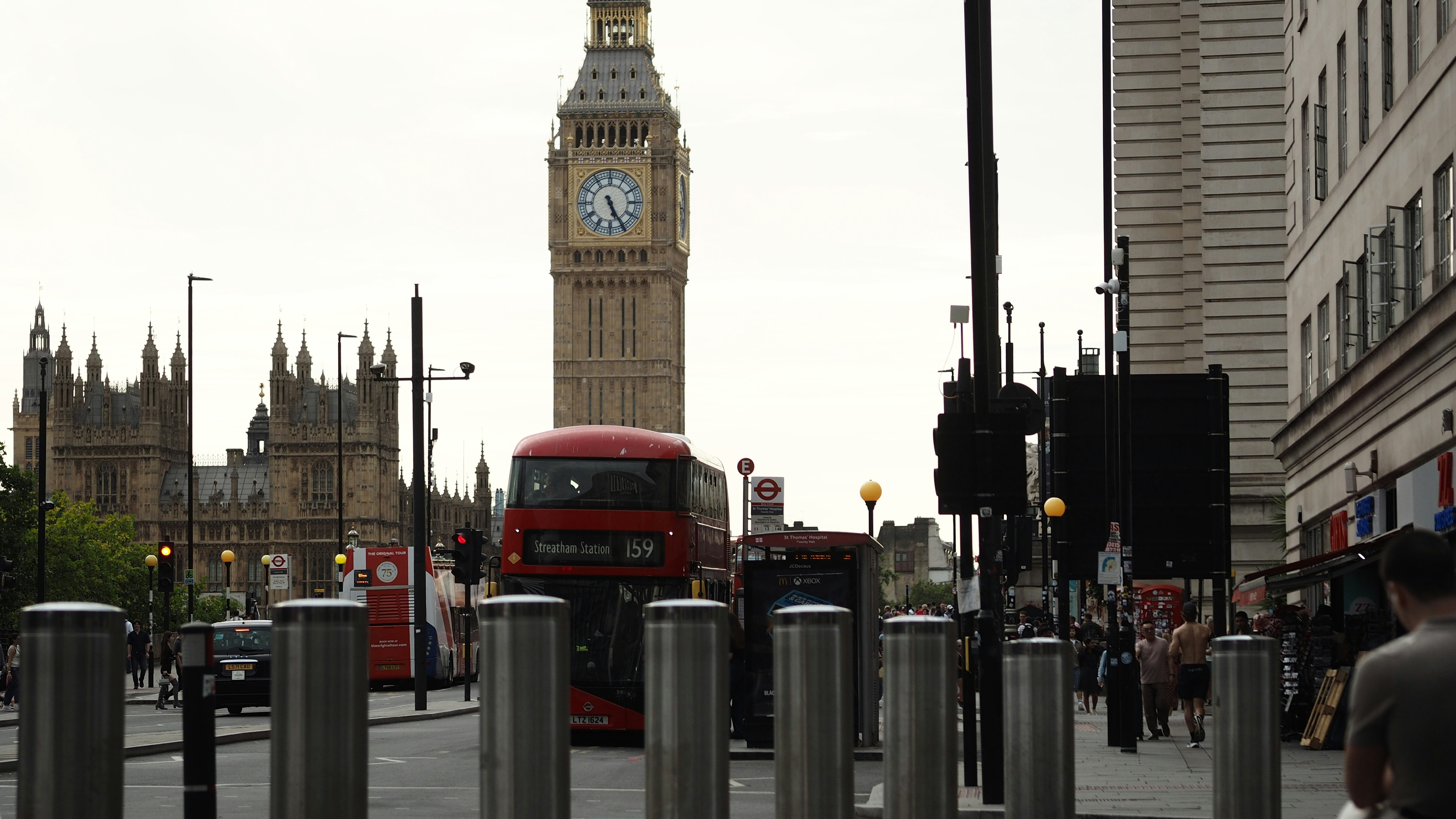 London Street Pulse: Red Buses, Big Ben, and a Crowd