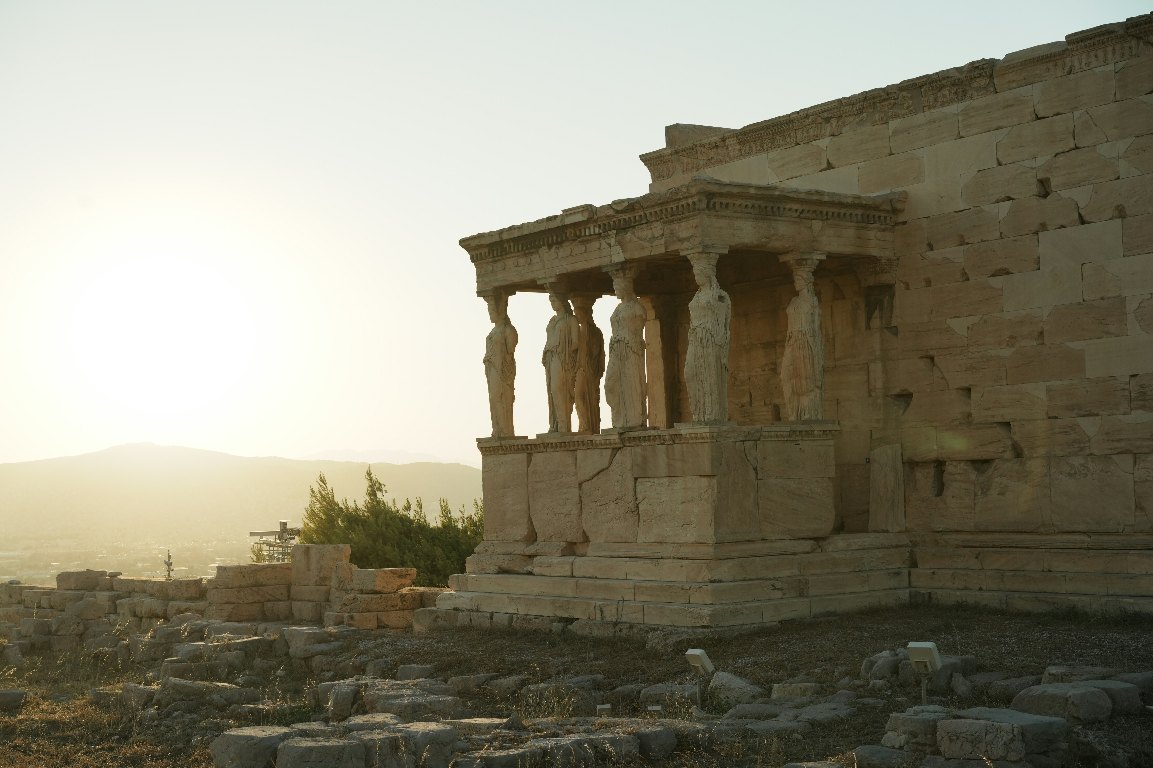 Sunlit Apse: The ancient colonnade overlooking the rocky foreground