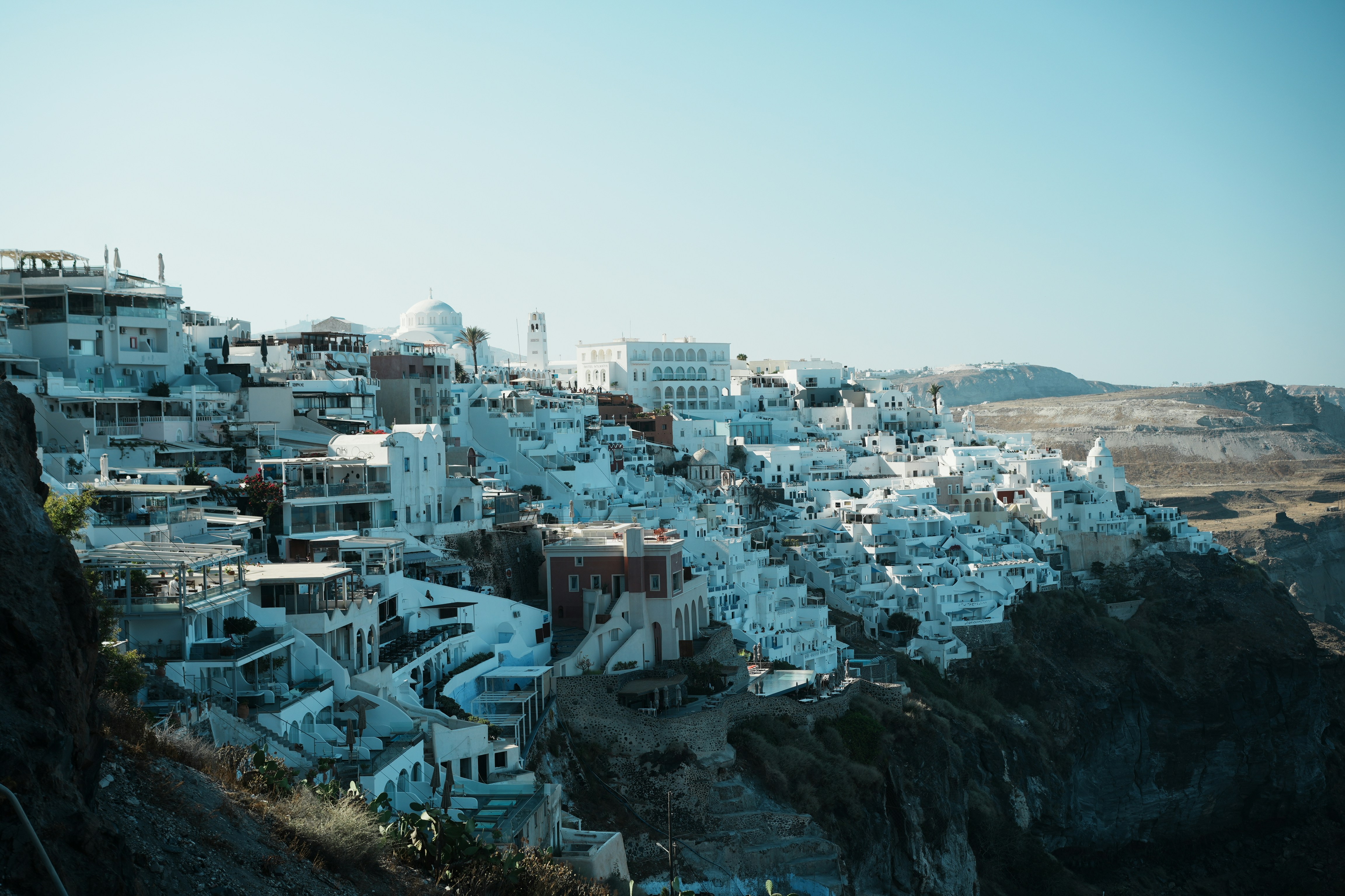Whitewashed cliffside village perched along a sunlit Mediterranean ridge