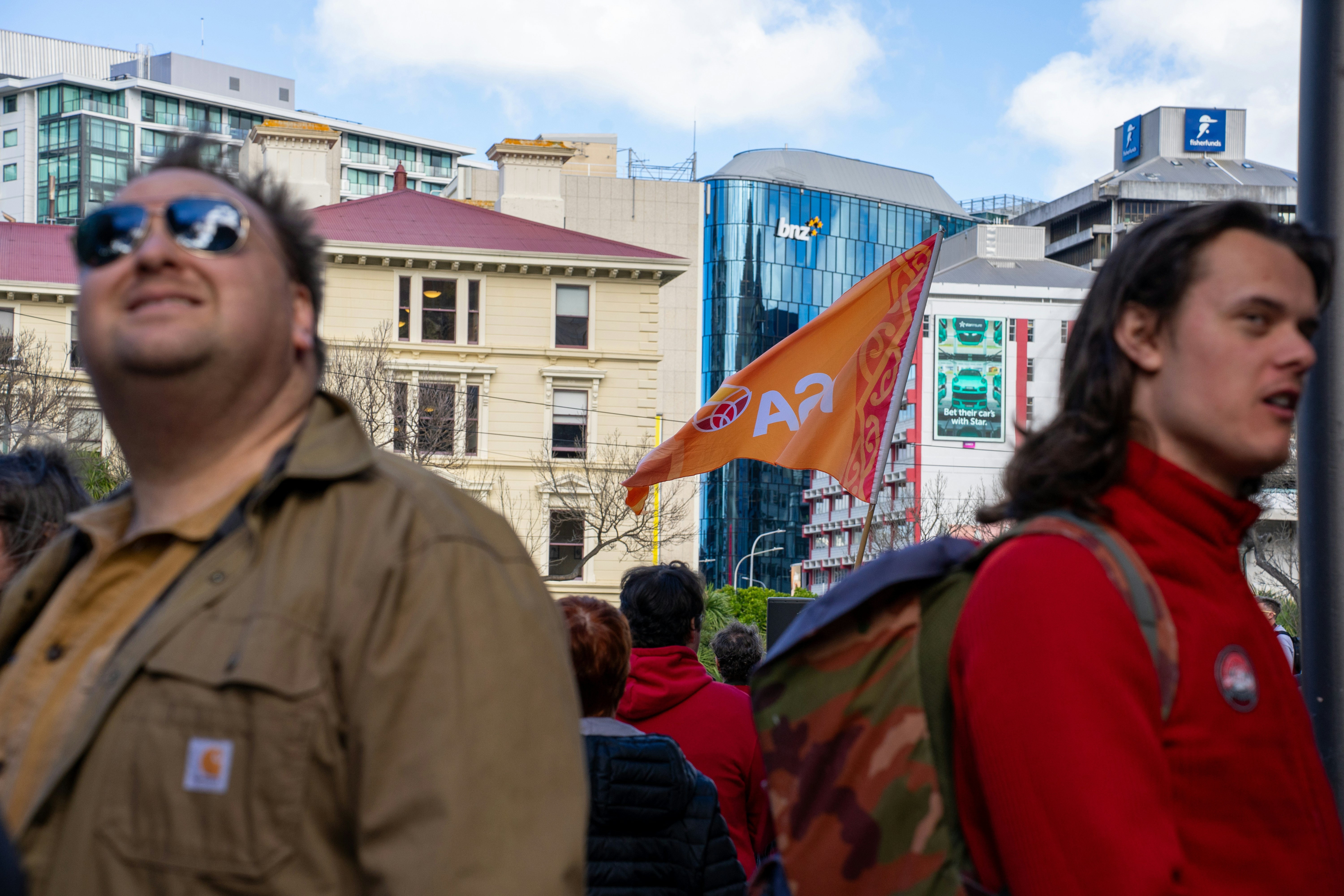Street Scene at a City Rally: Faces, Flags, and Urban Facades