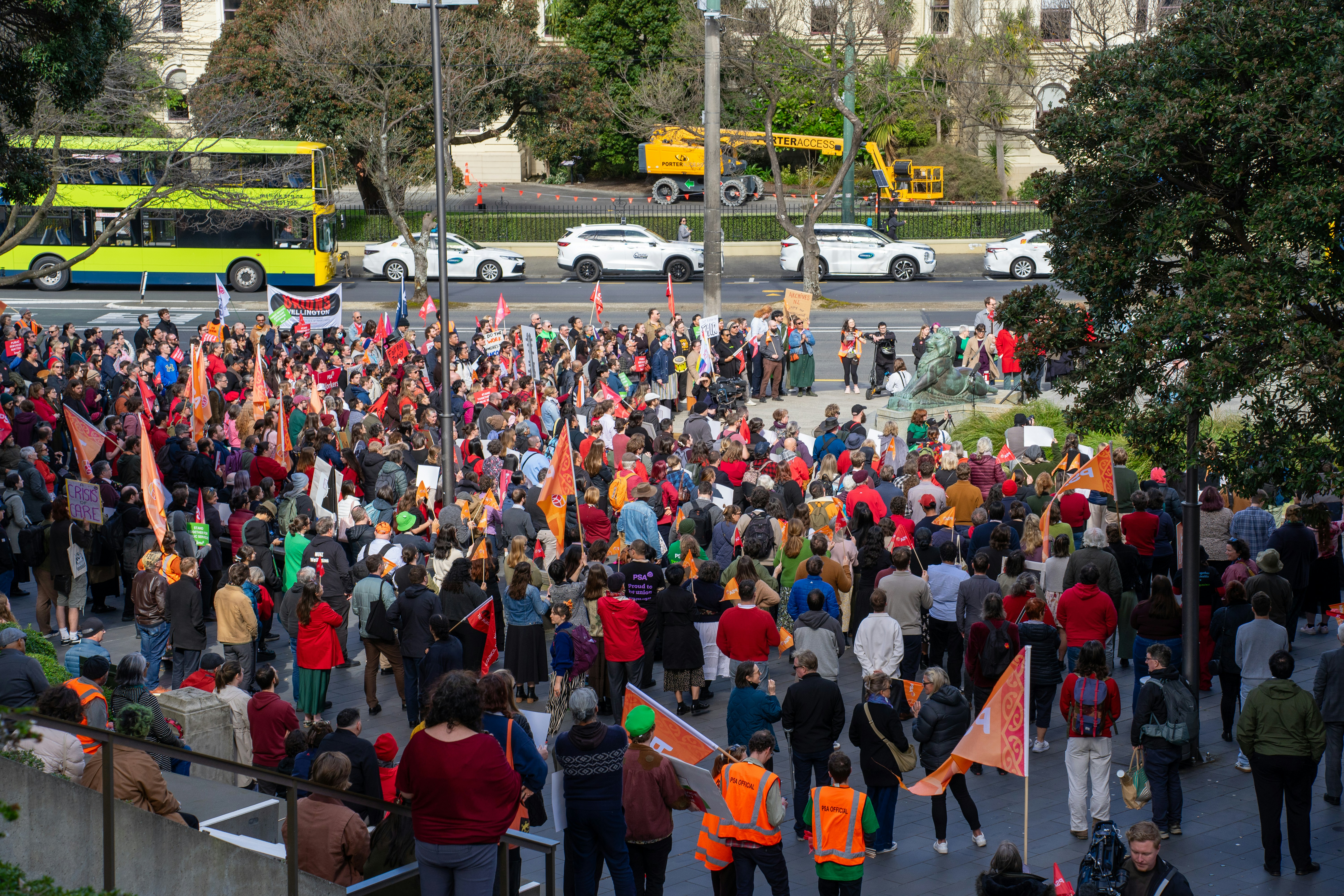 Crowd in Motion: A City Street Rally Bridging Voices and Flags