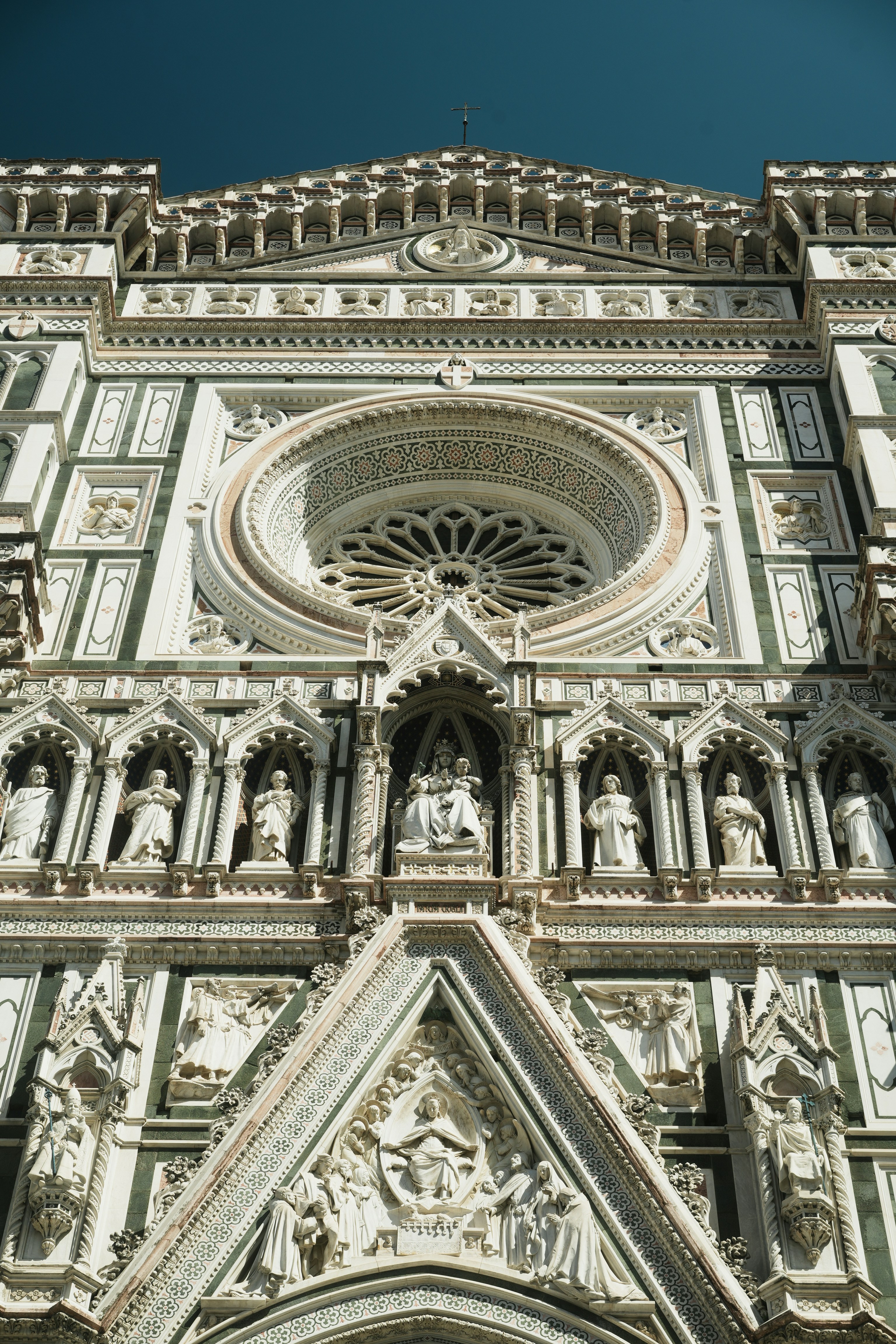 Ornate Cathedral Facade: Carved Rose Window and Sculpted Frieze