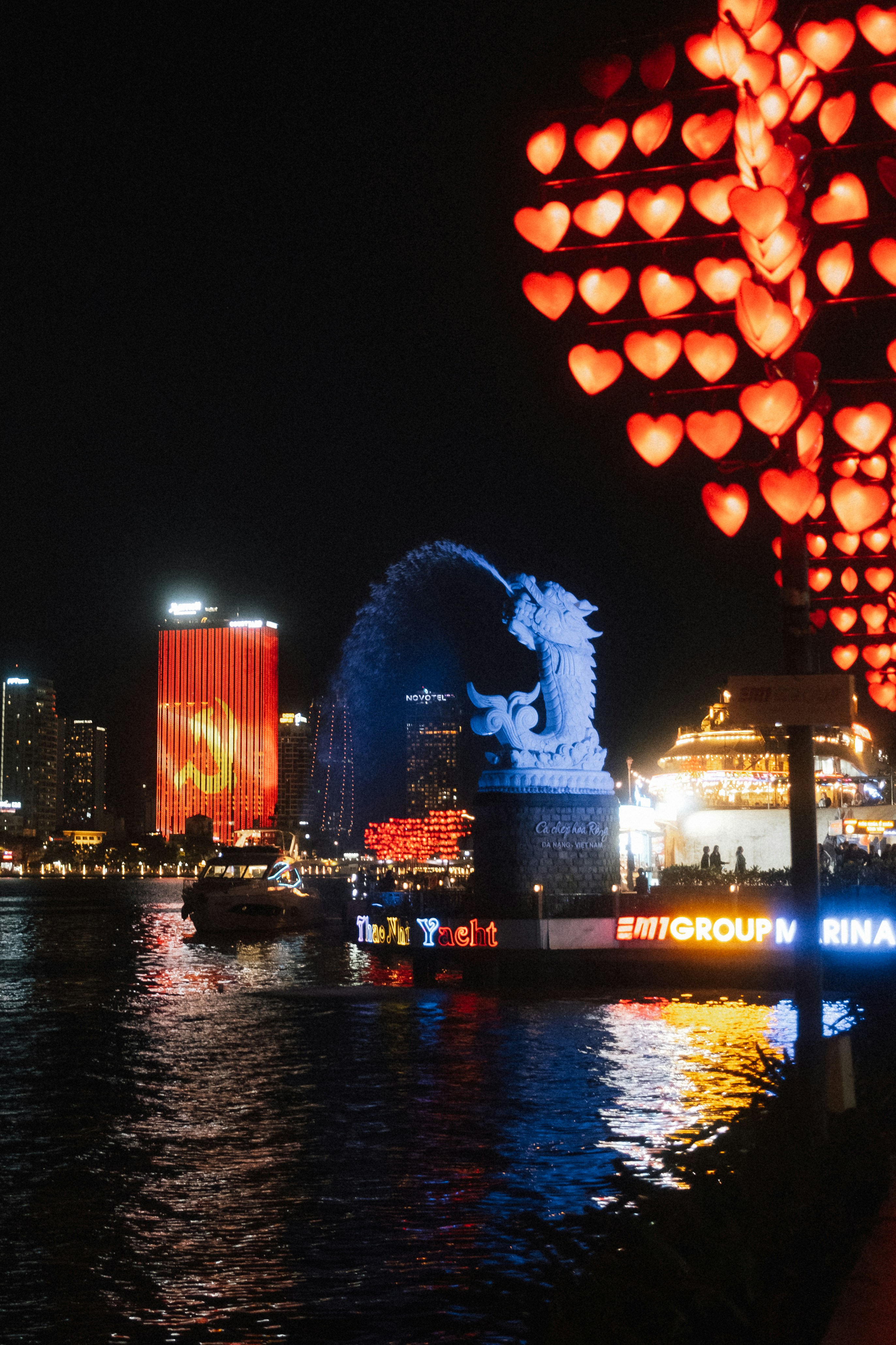 Neon Harbor: Dragon Statue and Heart Lanterns Under Night Steam