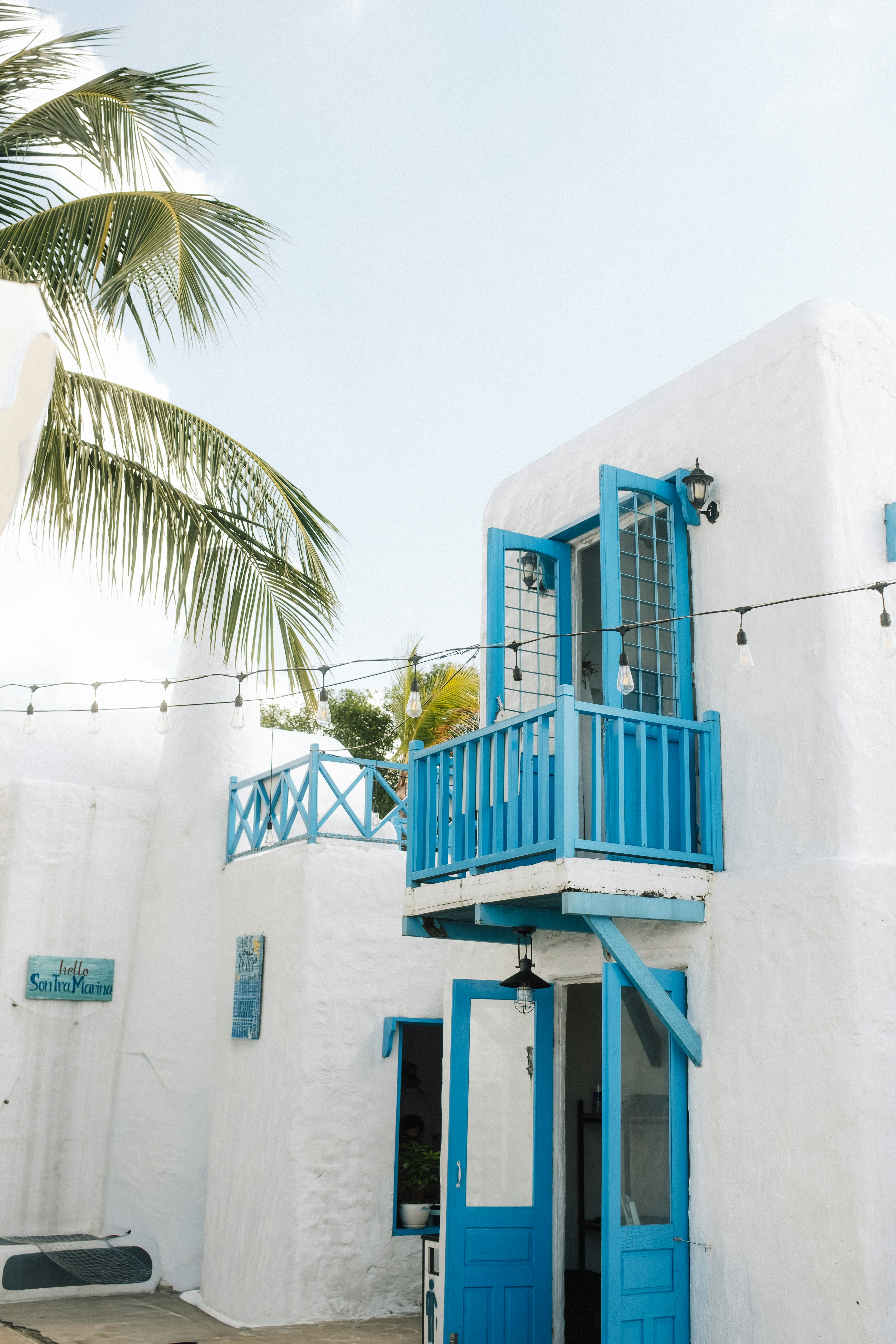 Blue Balcony Over White Walls in Sunny Shoreline Village