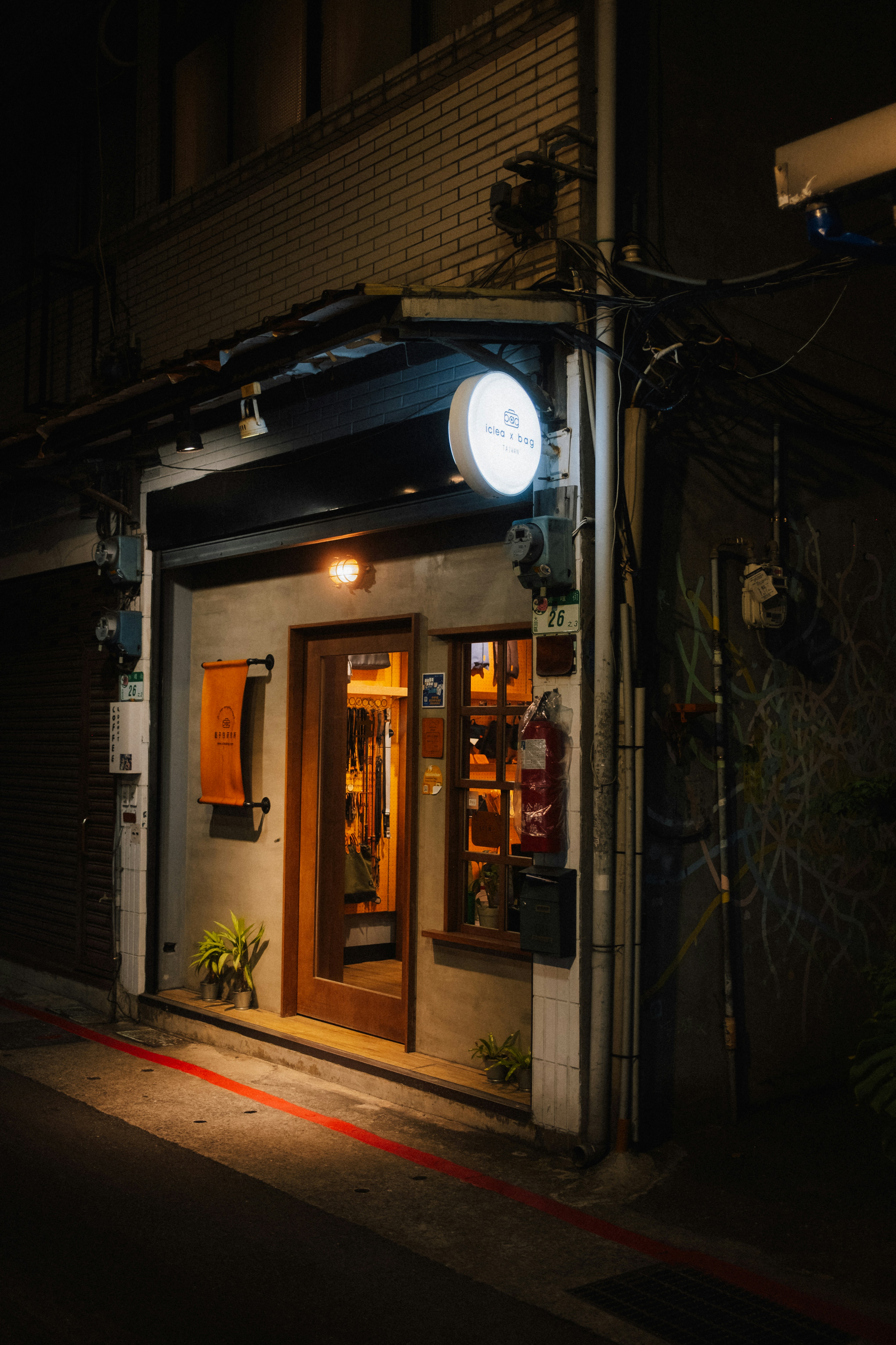 Warm glow spilling from a boutique doorway on a quiet night street