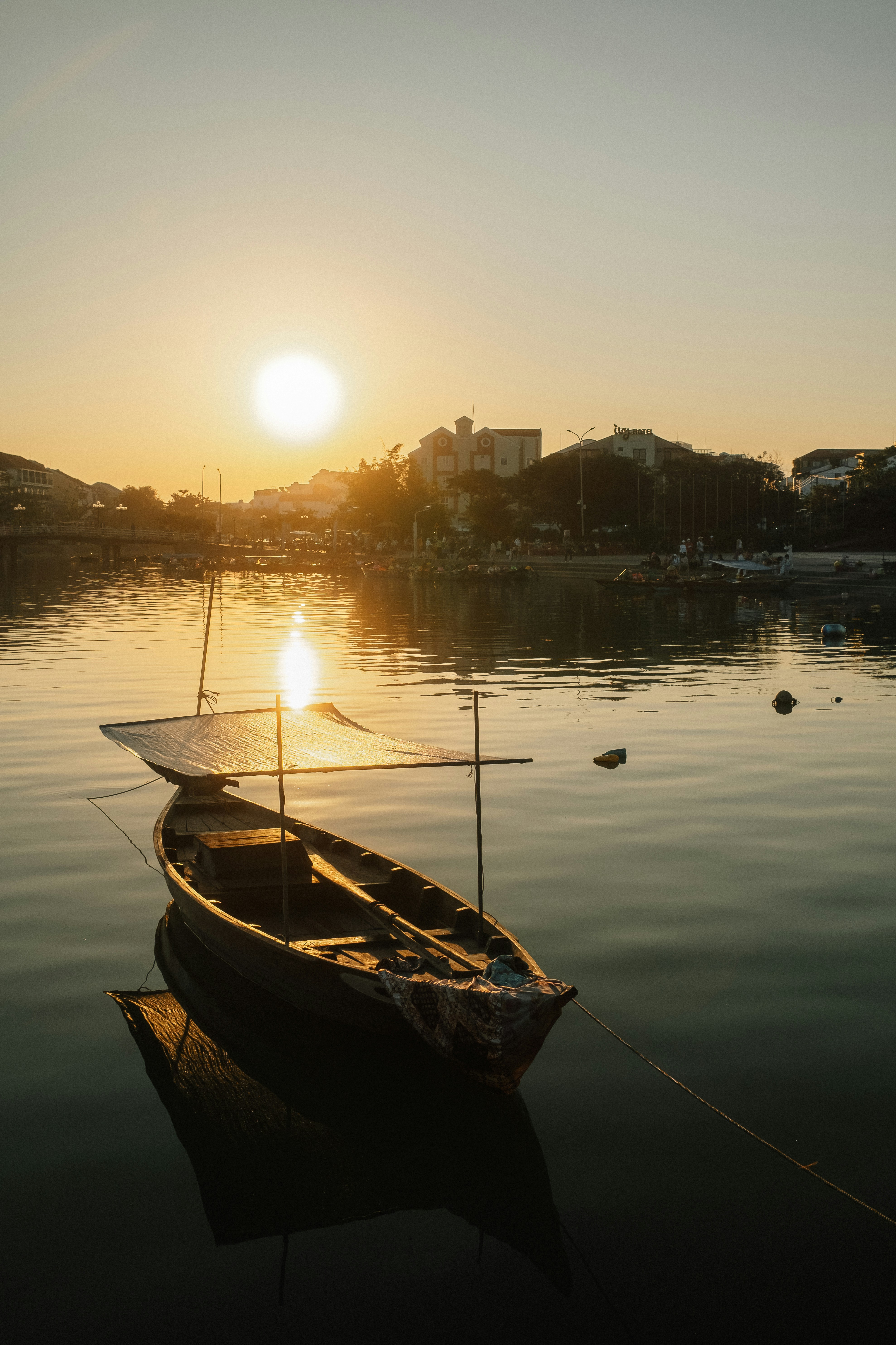 Sunlit Harbor: An Evening Boat Adrift on Glassy Water