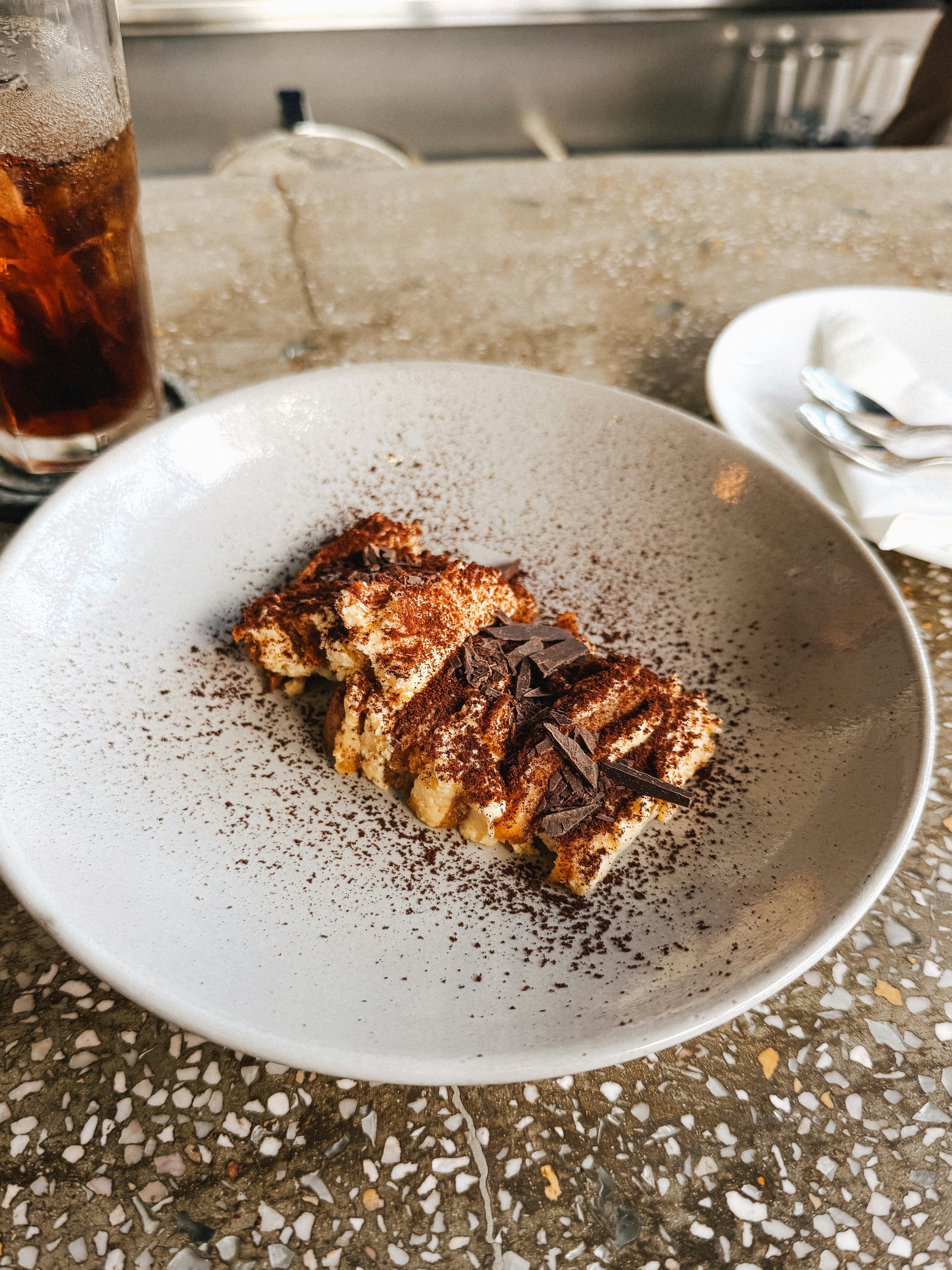Layers of Indulgence: Tiramisu-Style Crepe Cakes on a Rustic Plate