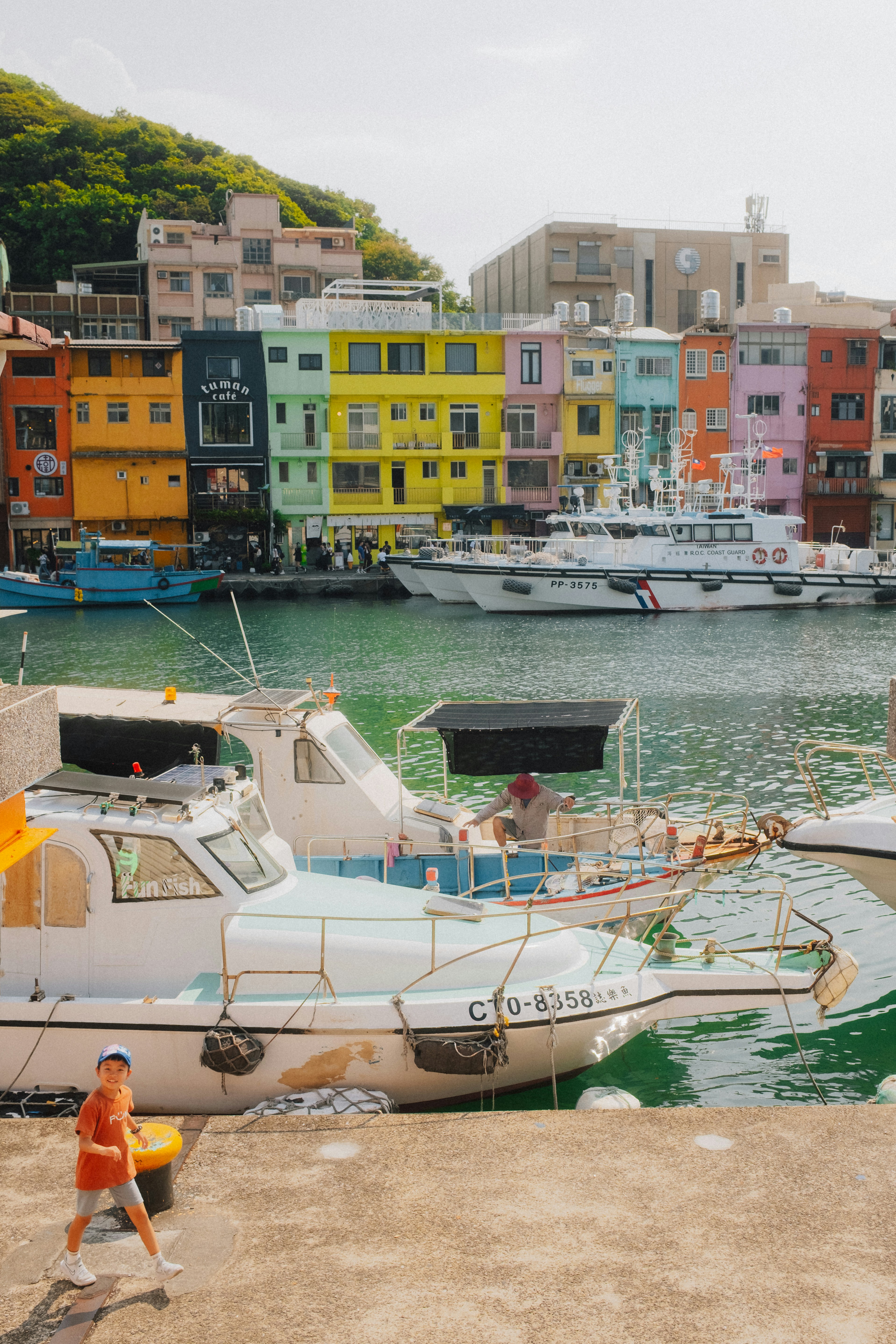 Rainbow Row by the Harbor: Colorful Buildings Reflecting on Calm Waters