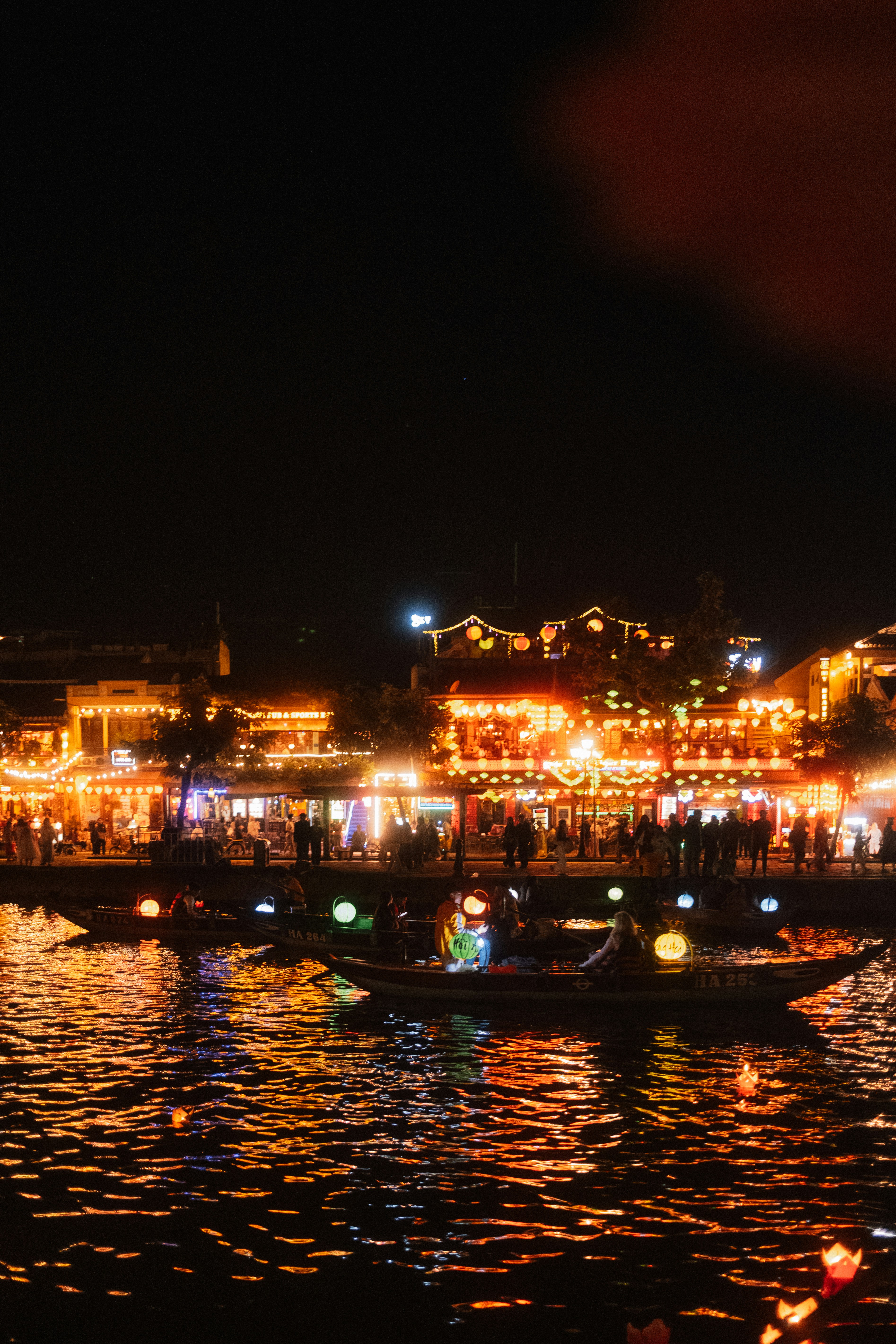 Neon Reflections: Night Boats and Lantern-lit Waterfront