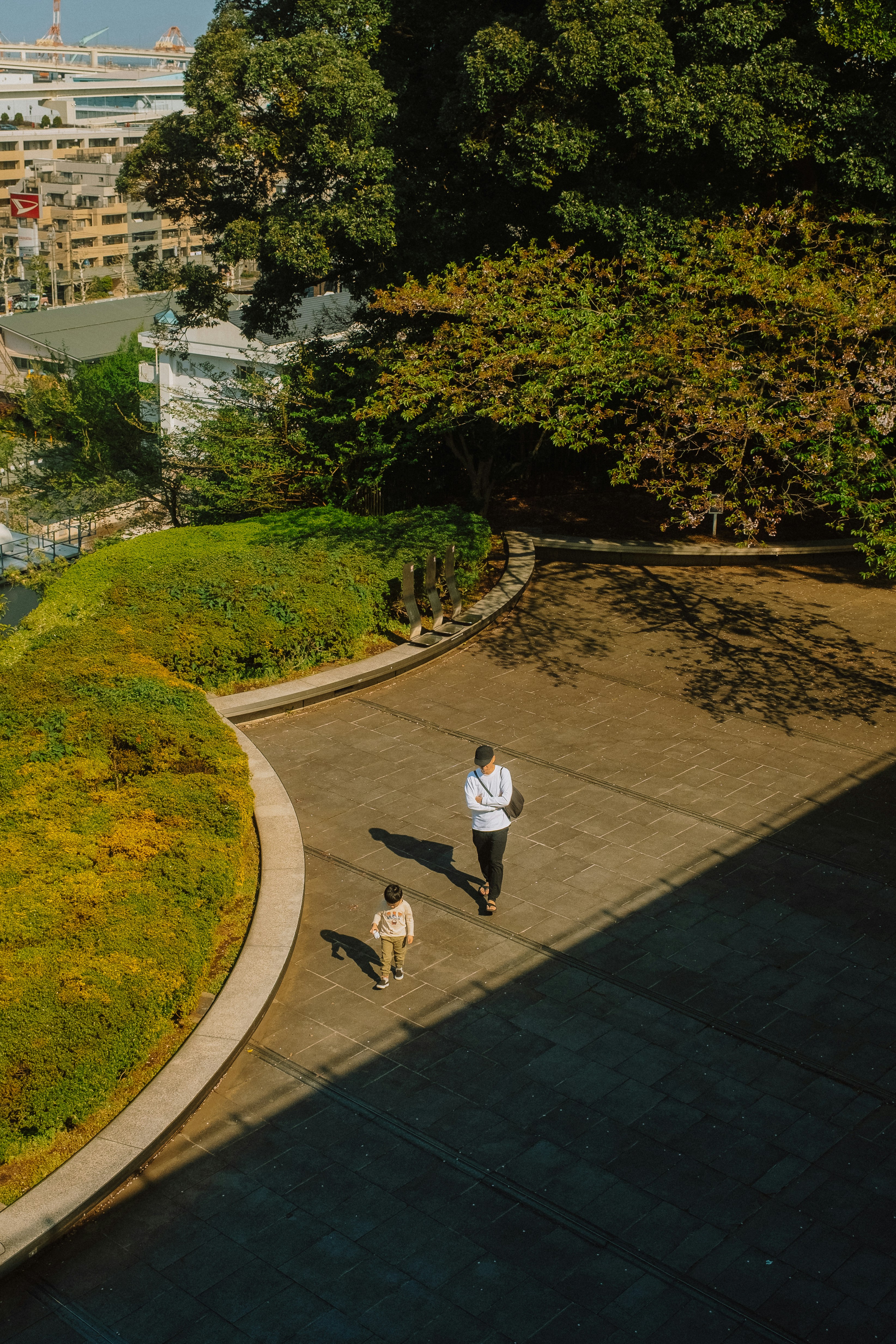 A Quiet Moment: Father and Child in the Curved Courtyard