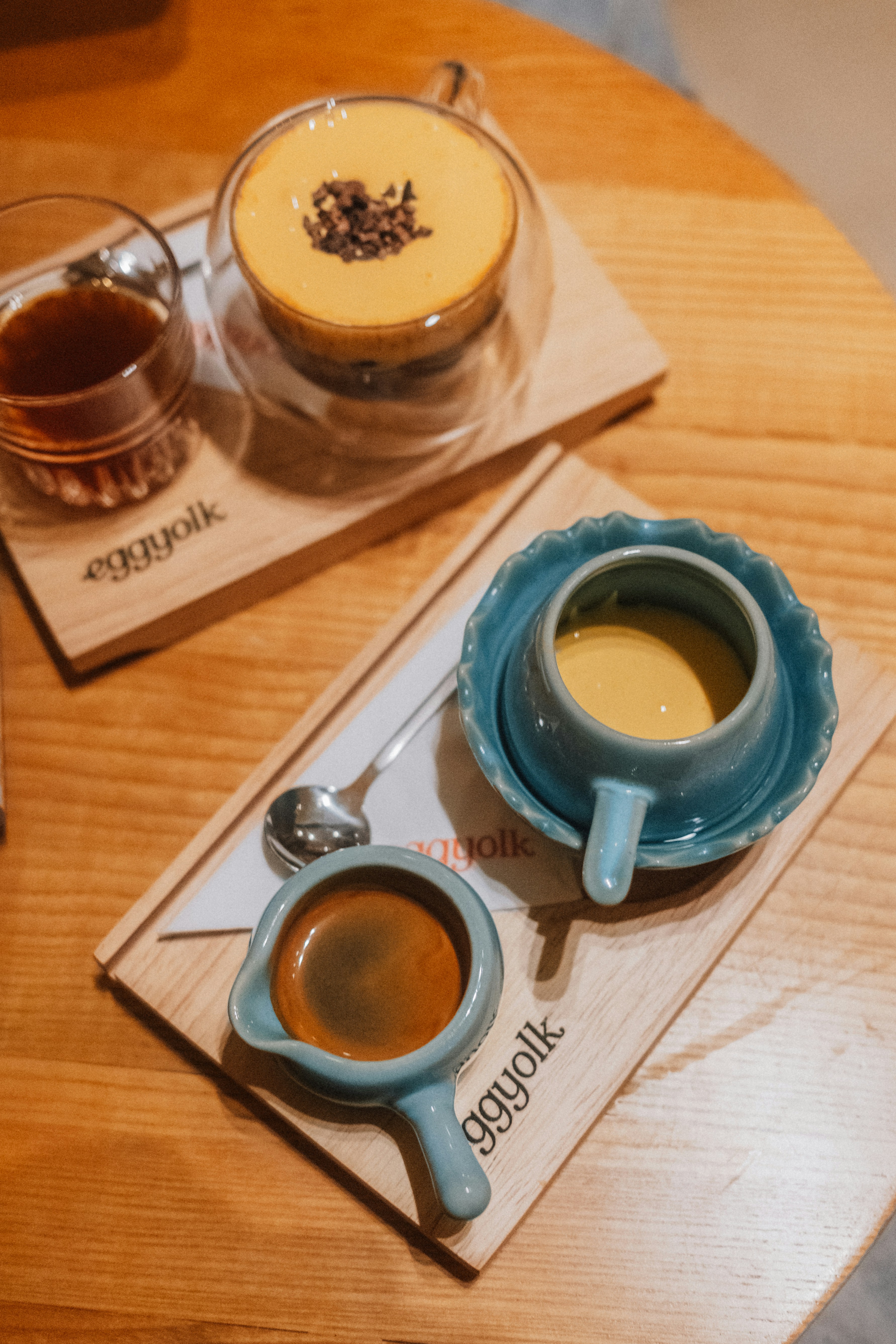 Blue Ceramic Pour: A Cozy Café Still Life with Espresso and Creamy Latte