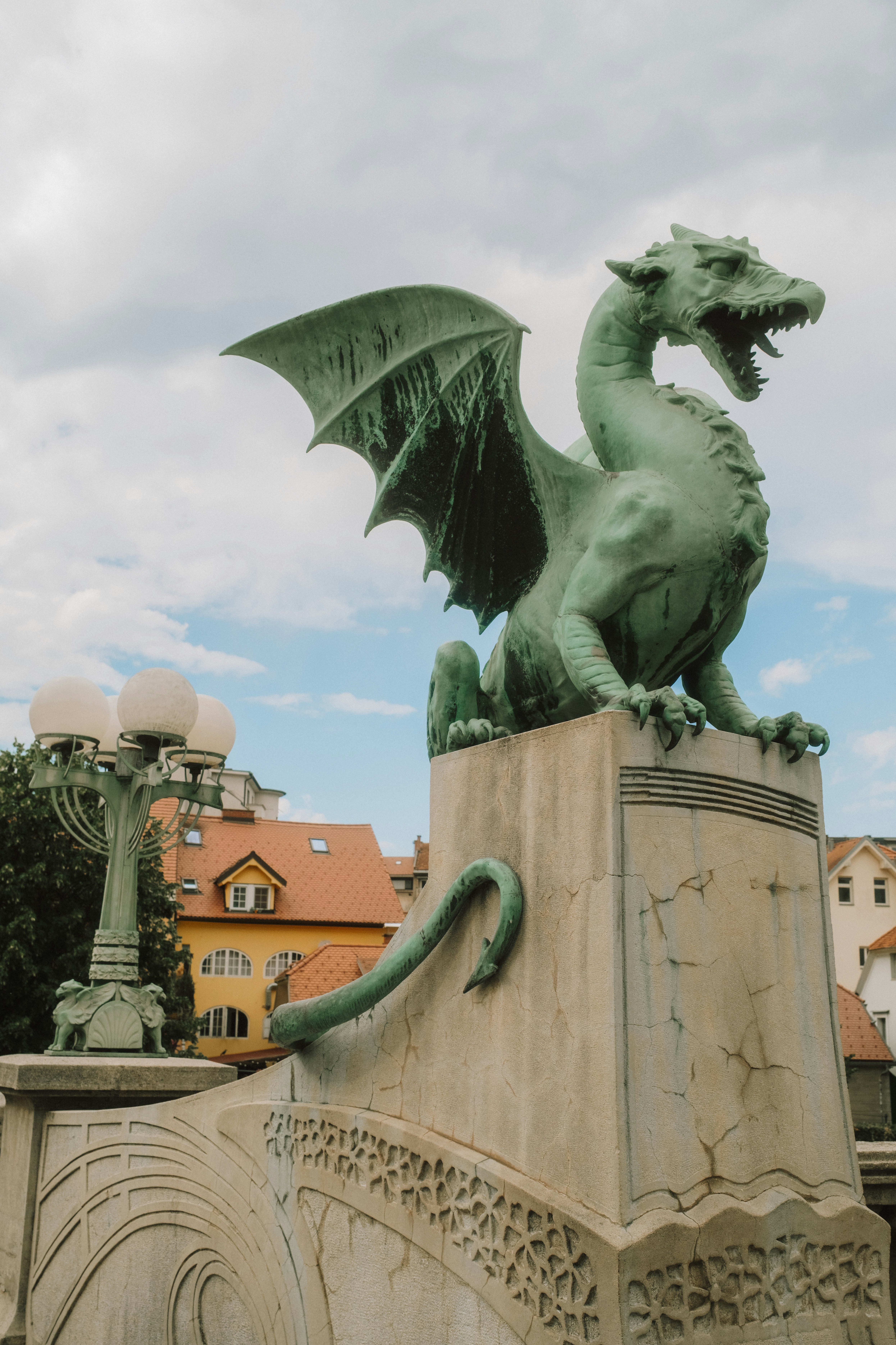 Dragon on the Pedestal: A Bronze Guardian Overlooking a Colorful Town