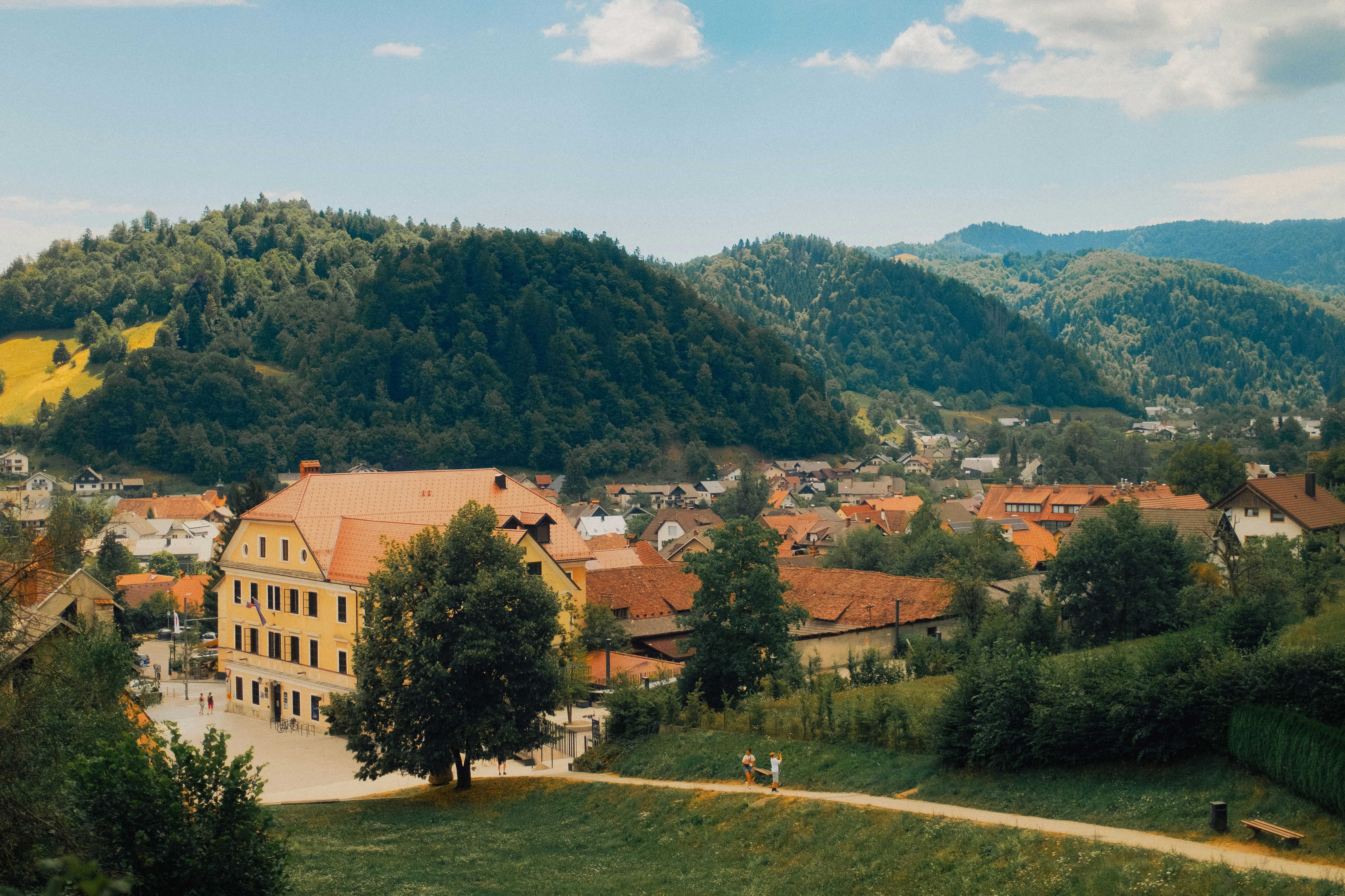 Pastoral Village Aglow: Autumn Hills and a Courtyard of Warm Turrets