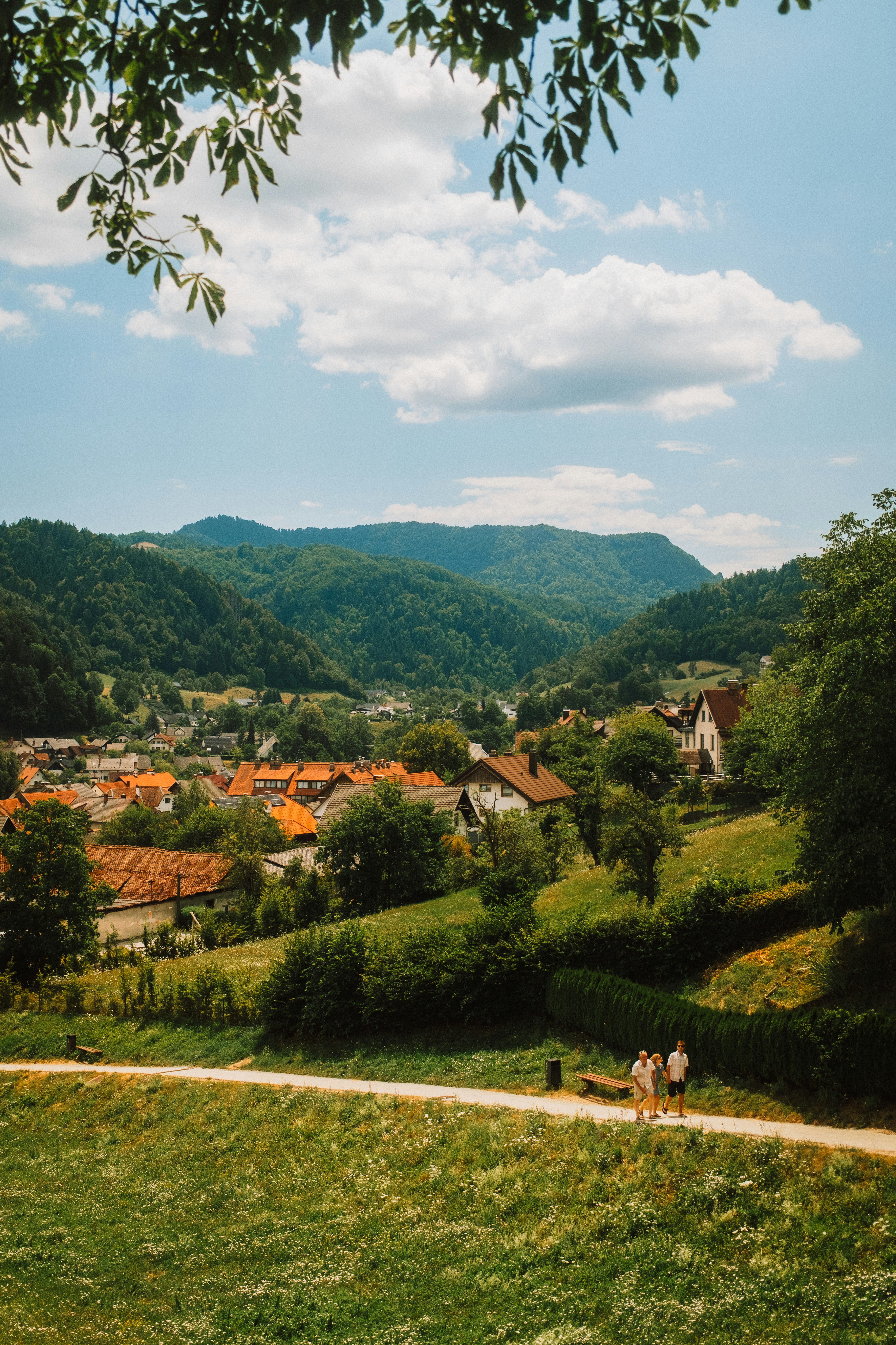 Hilltop Village Amid Green Valleys Under a Bright Sky