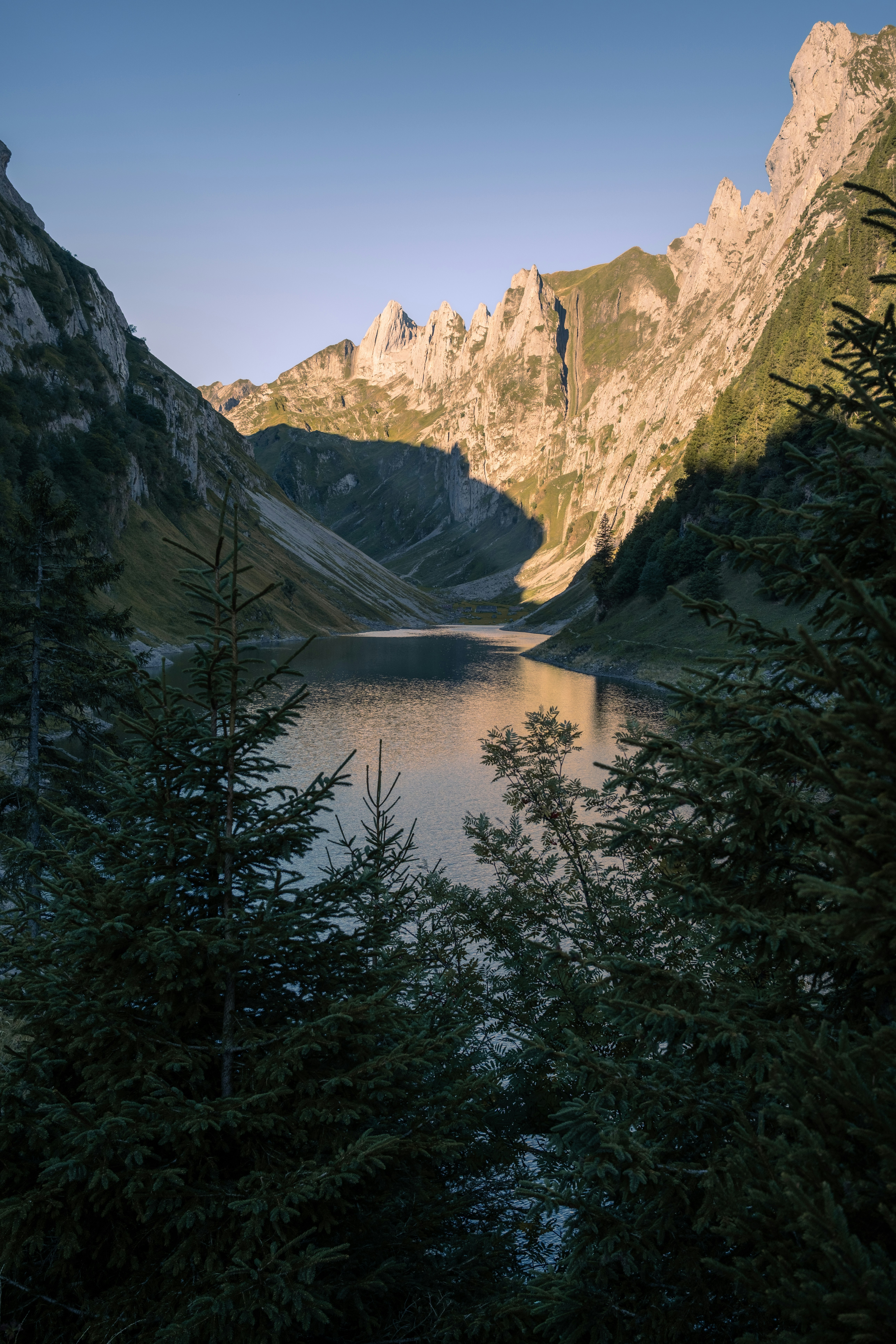 Sunlit Spine: Alpine Peaks Over a Quiet Tarn