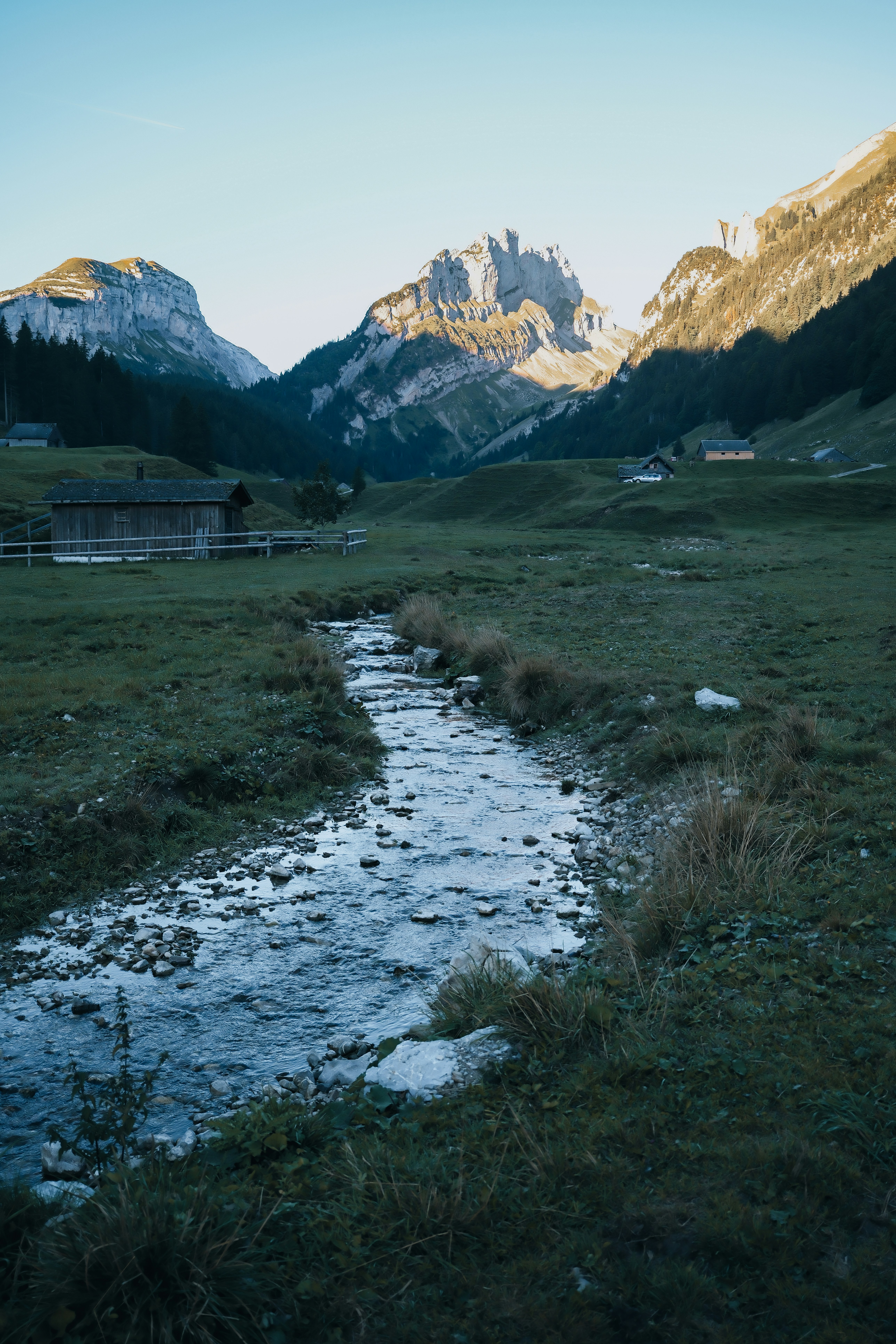 Sunlit Peaks Over a Quiet Alpine Creek