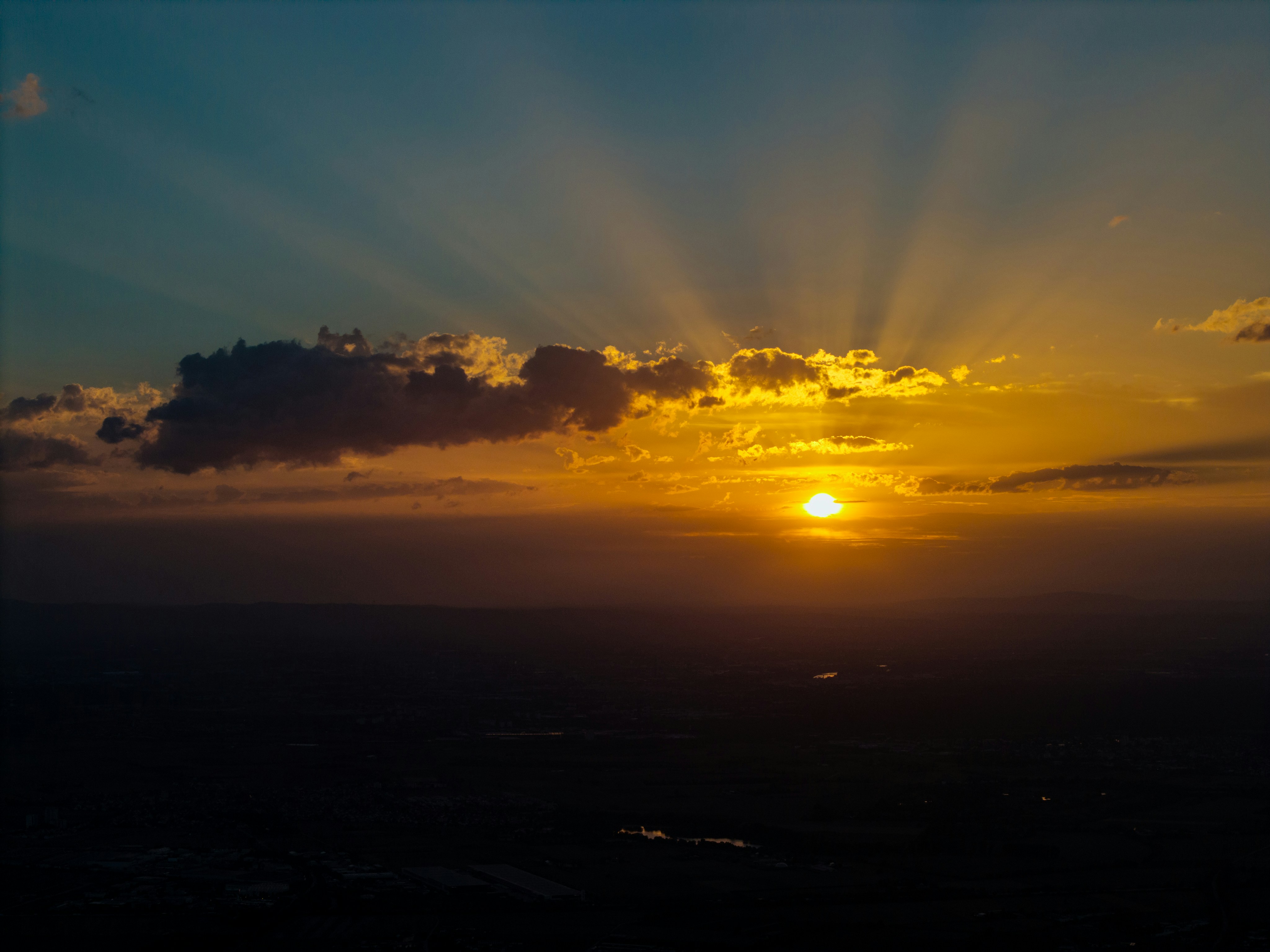 Sunburst over the Horizon: A Quiet Dusk from Above