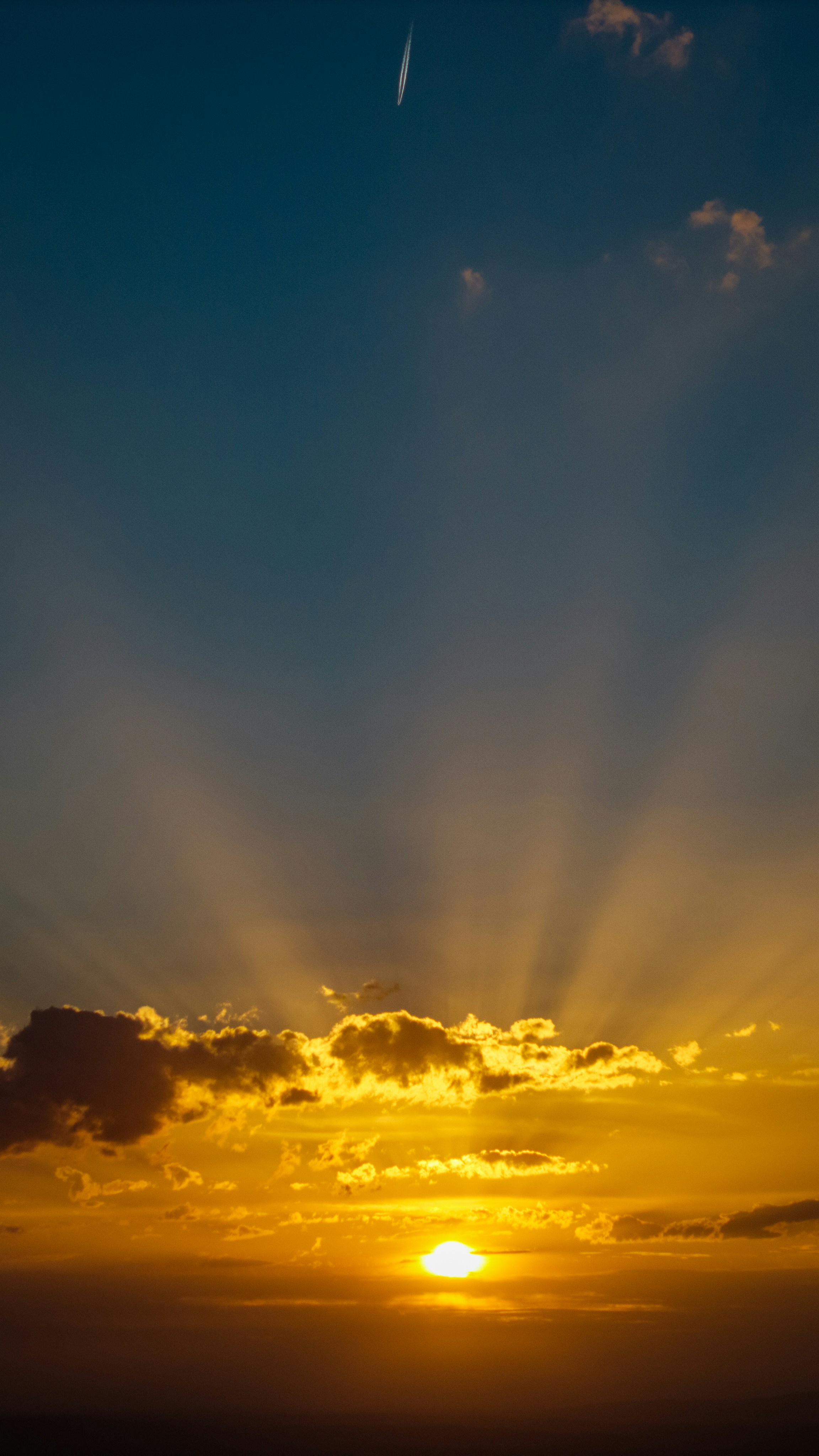 Sunrise Crown: Rays over the Horizon as a Jet Streaks Above