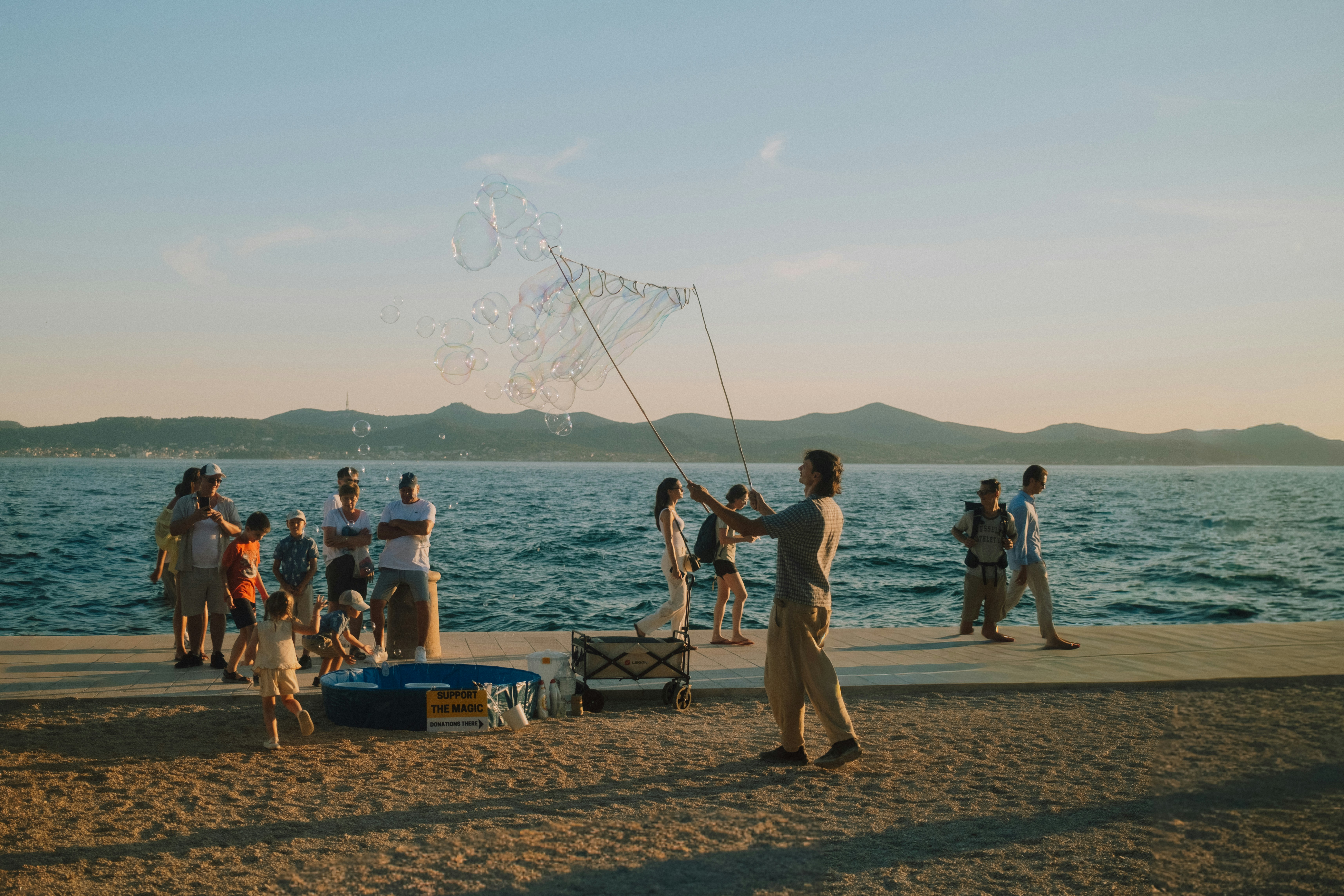 Bubble Burst by the Sea: A Sunlit Waterfront Moment