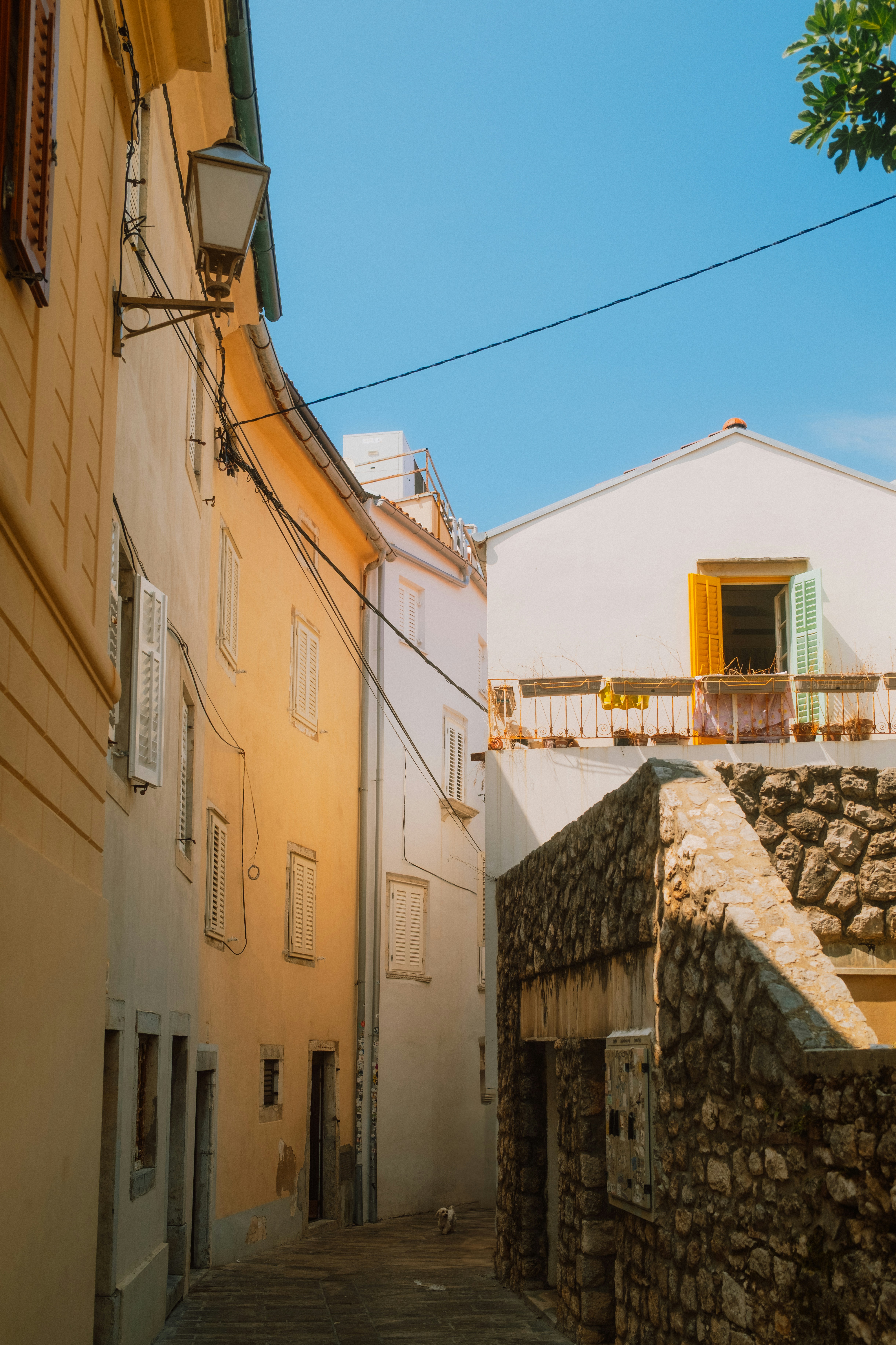 Sunlit Alleyway Between Warm Terracotta Facades