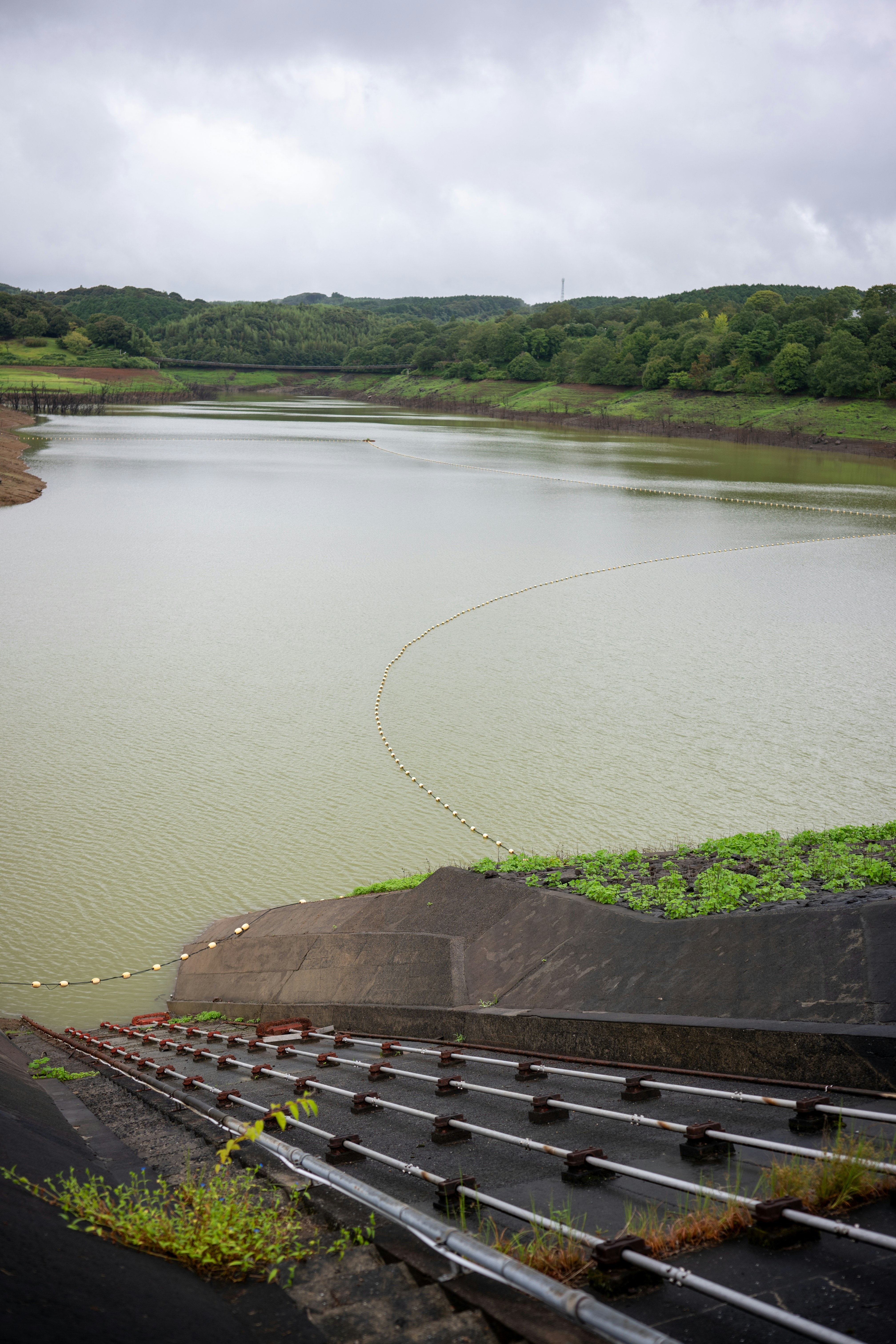 Curved Boundary: A Reservoir Spillway Sweeps Into Quiet Waters