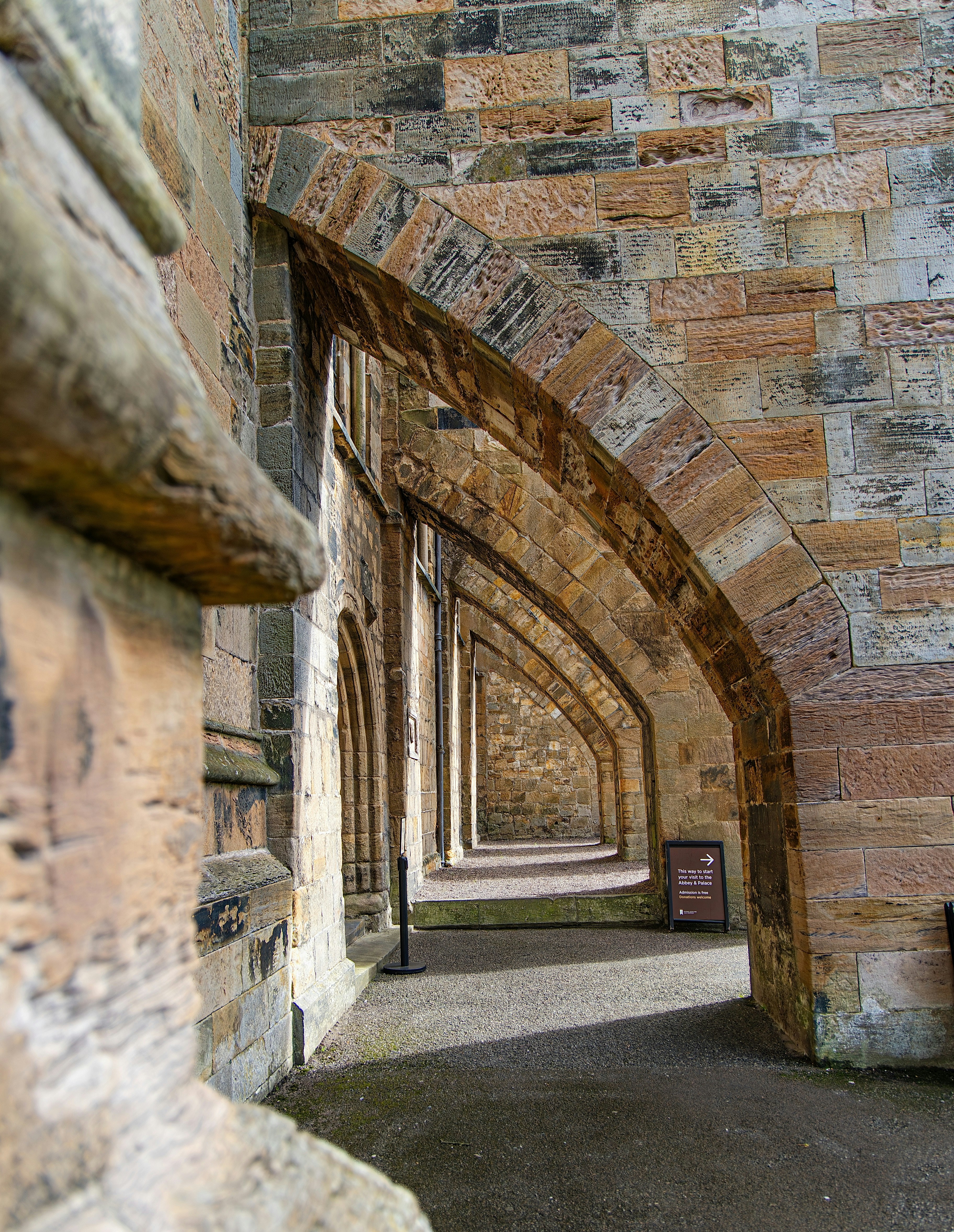 Stone Arcway Corridor: Receding arches and sunlit passage