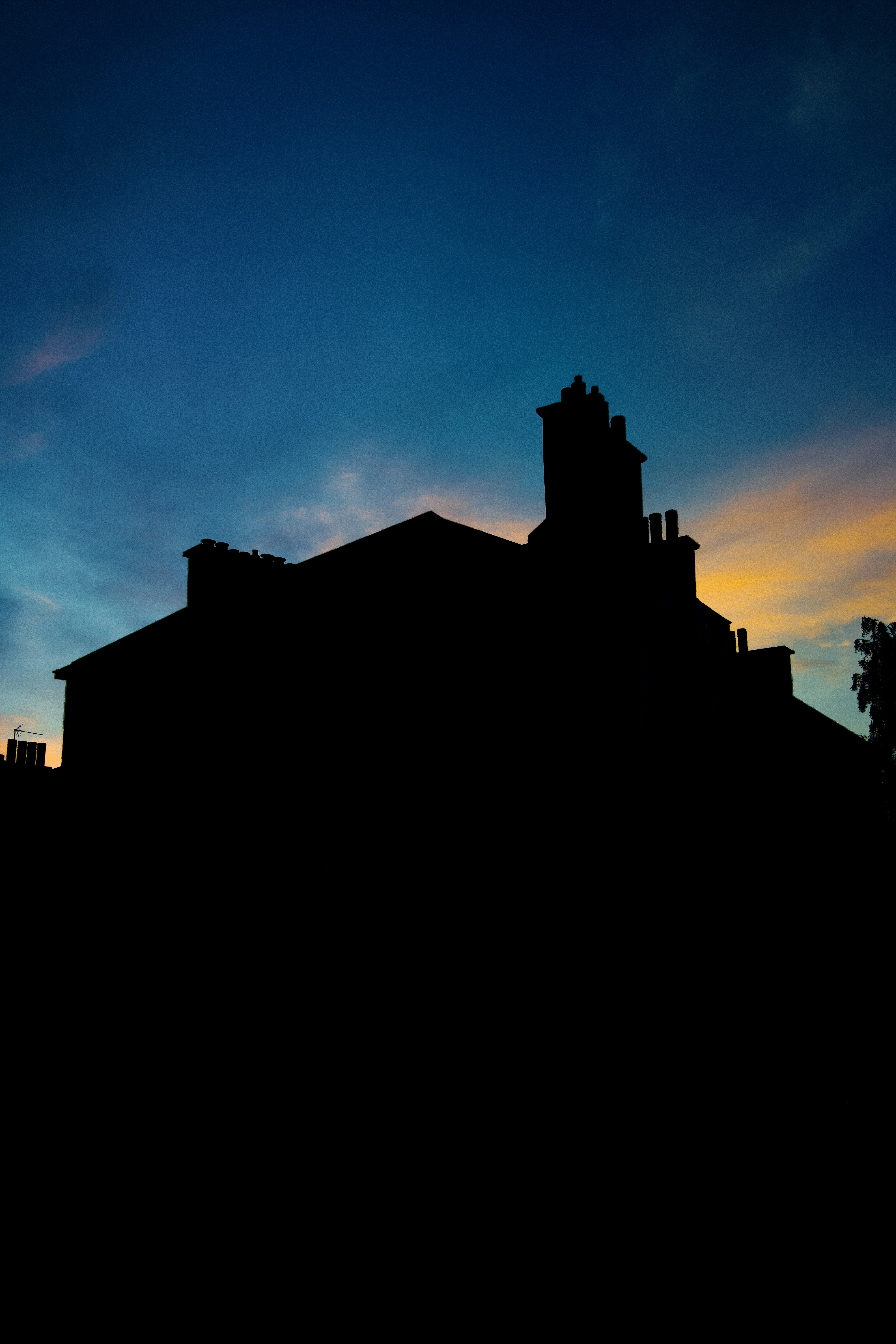 Silhouette Rooftops Against a Dusk Sky